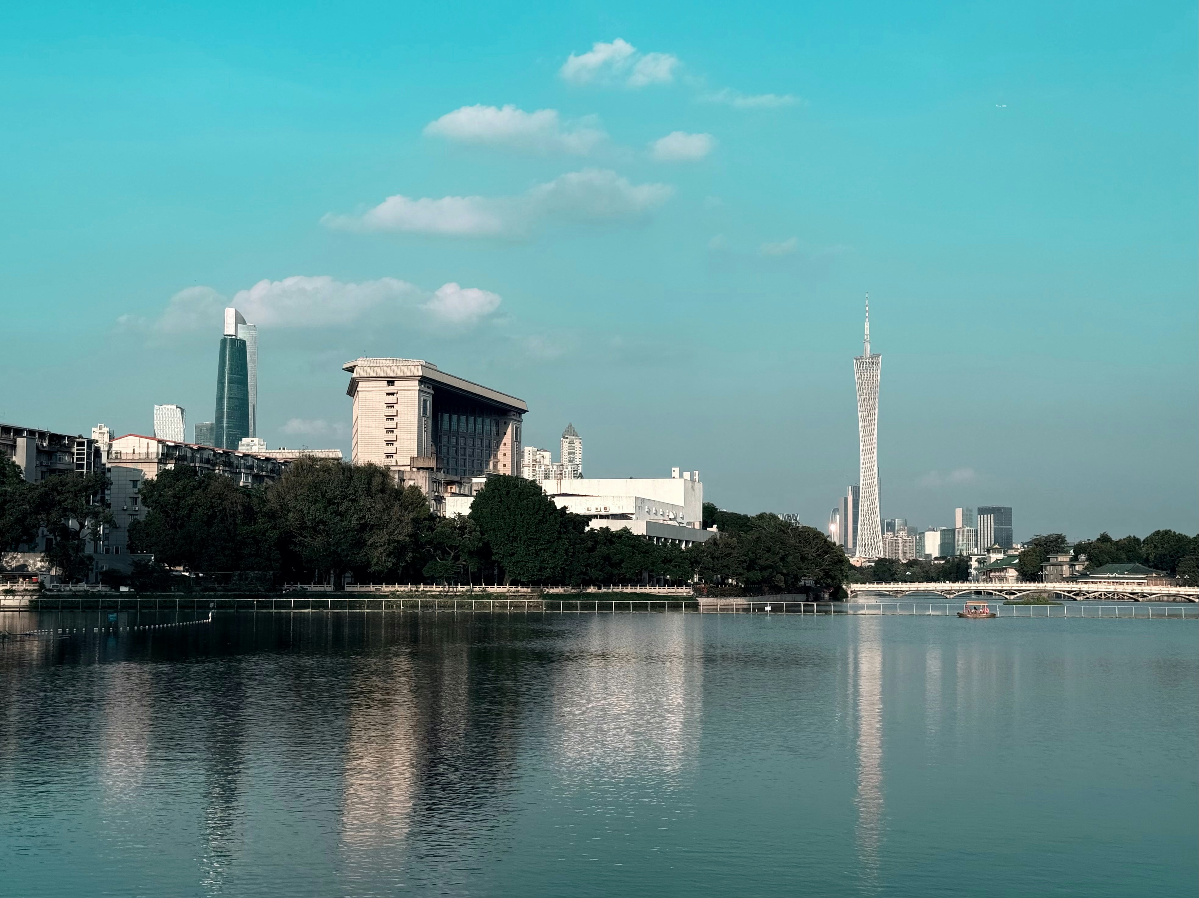 Guangzhou cityscape with canton tower reflected in the lake.