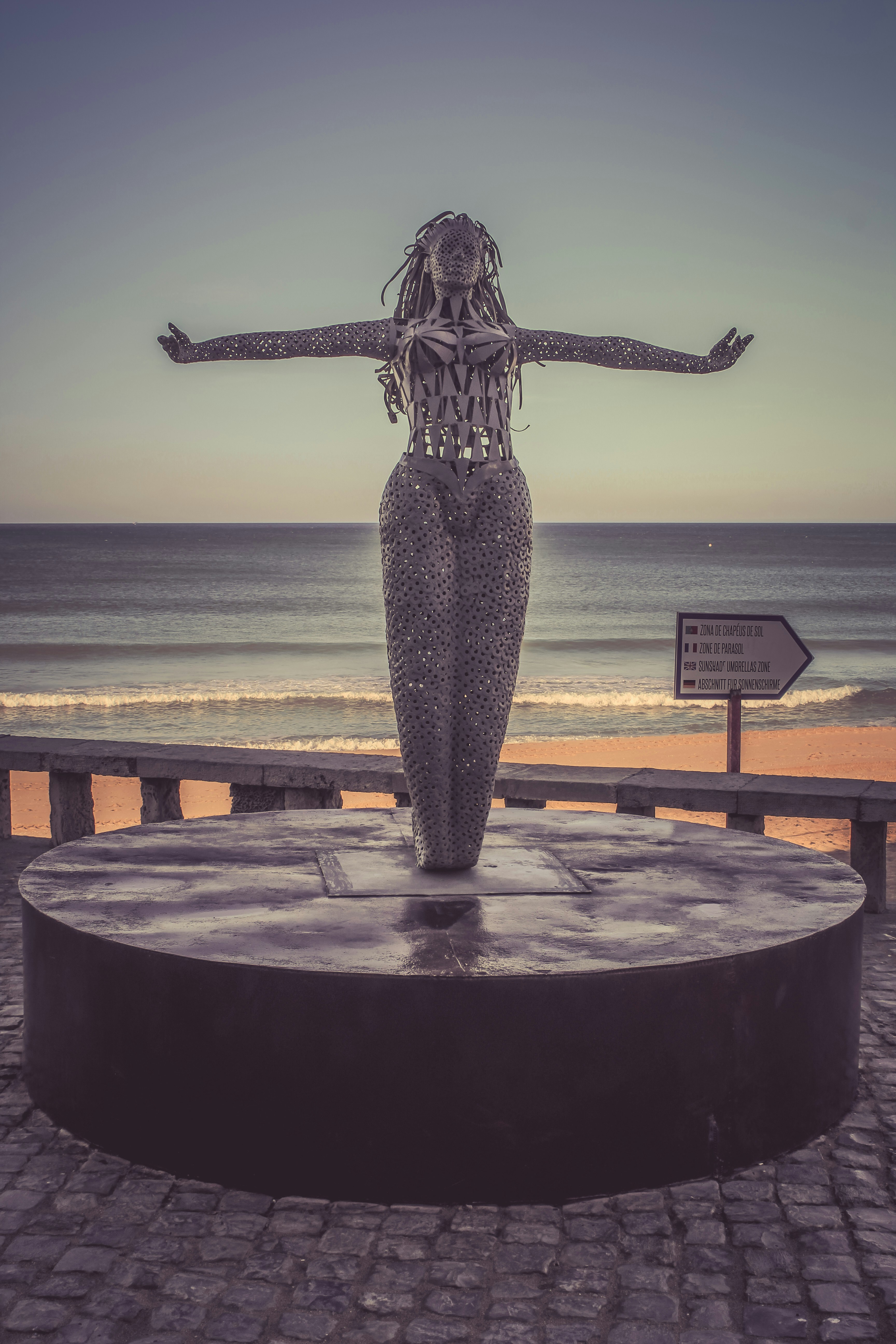 Sea-Front Statue with Open Arms on a Circular Plinth