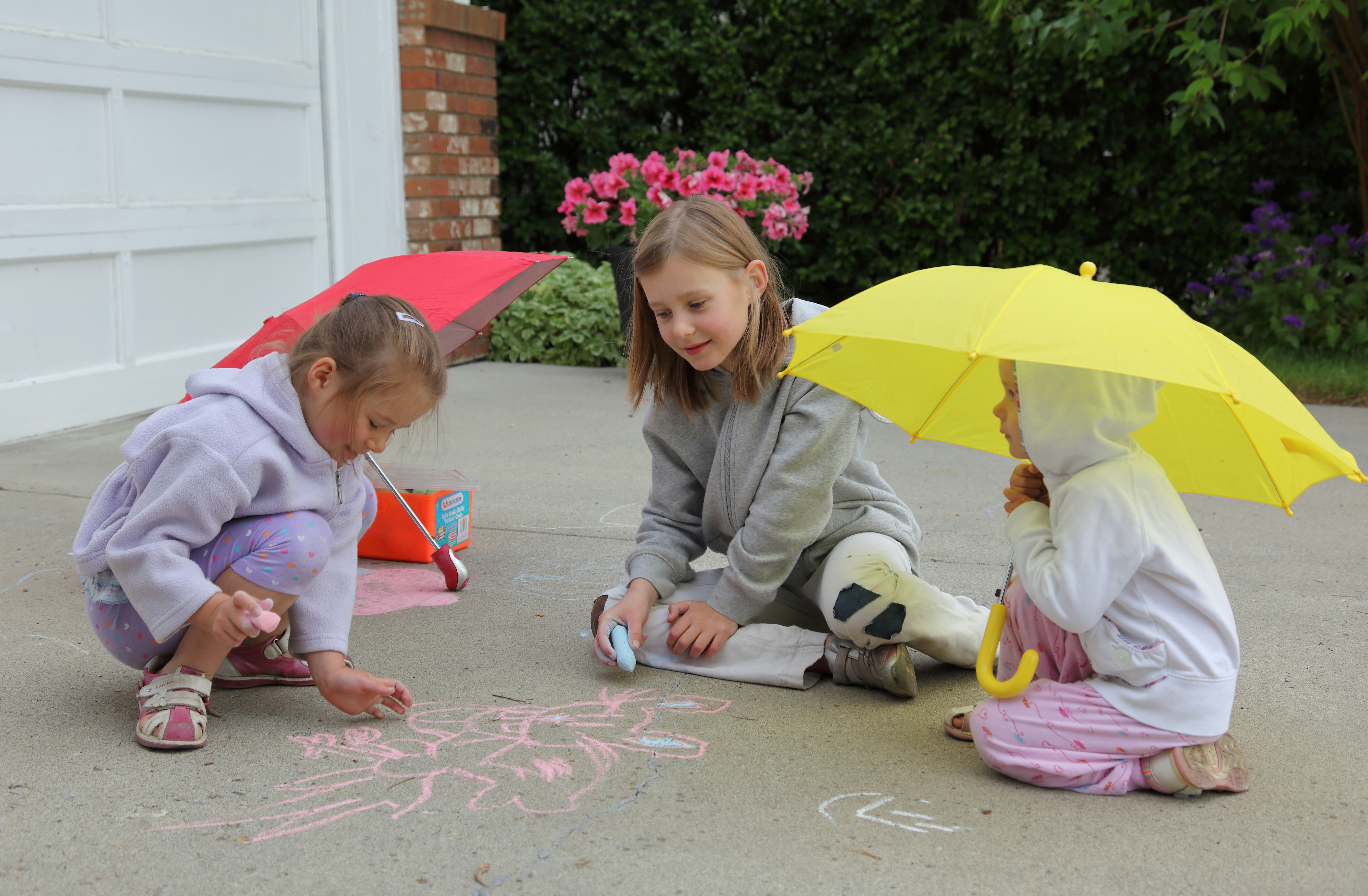 Side-by-Side Chalk Play: Kids Create Under Colorful Umbrellas
