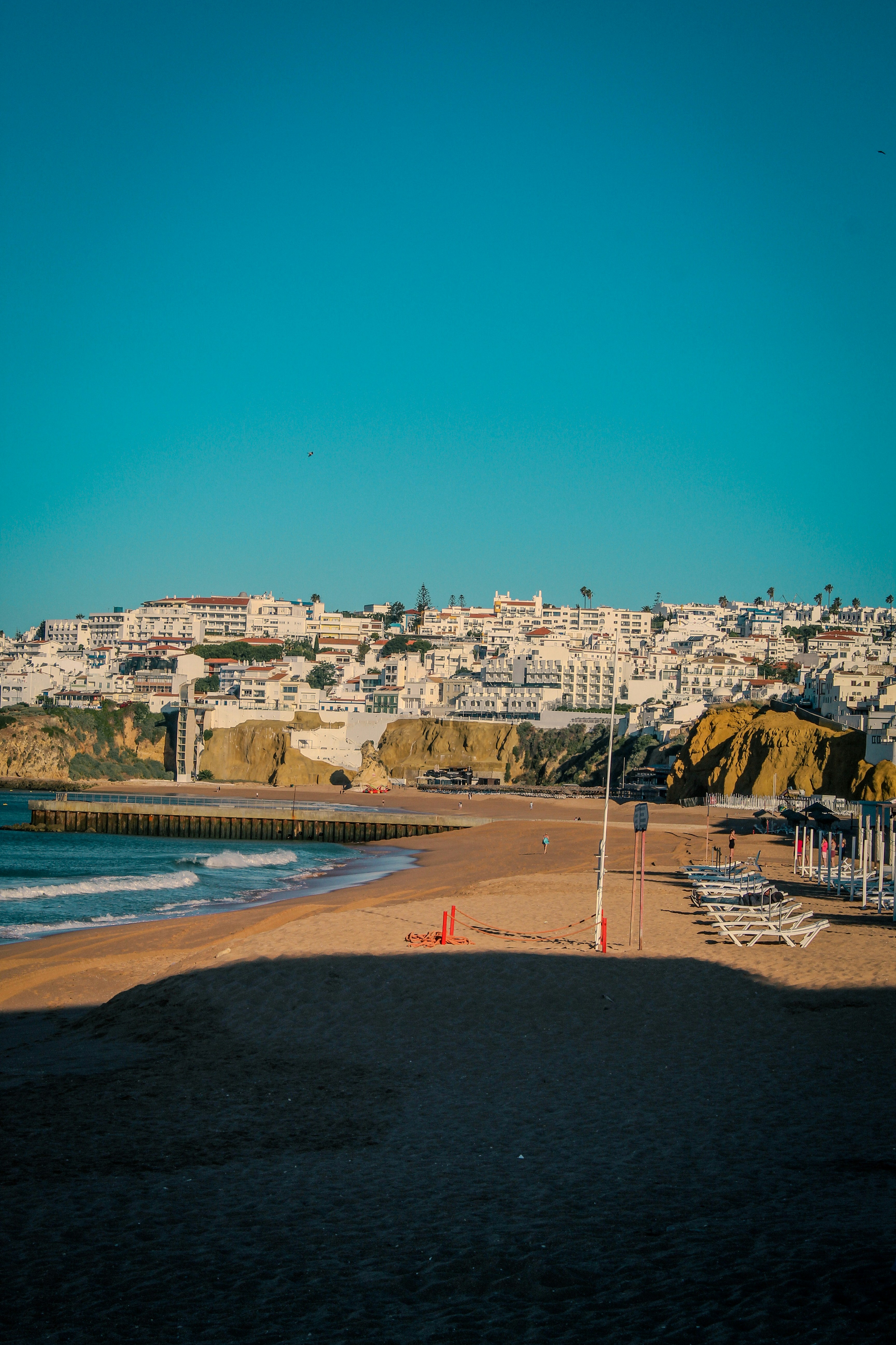 Sunlit Seaside Quarter: Terraced City Beneath Clear Blue Sky