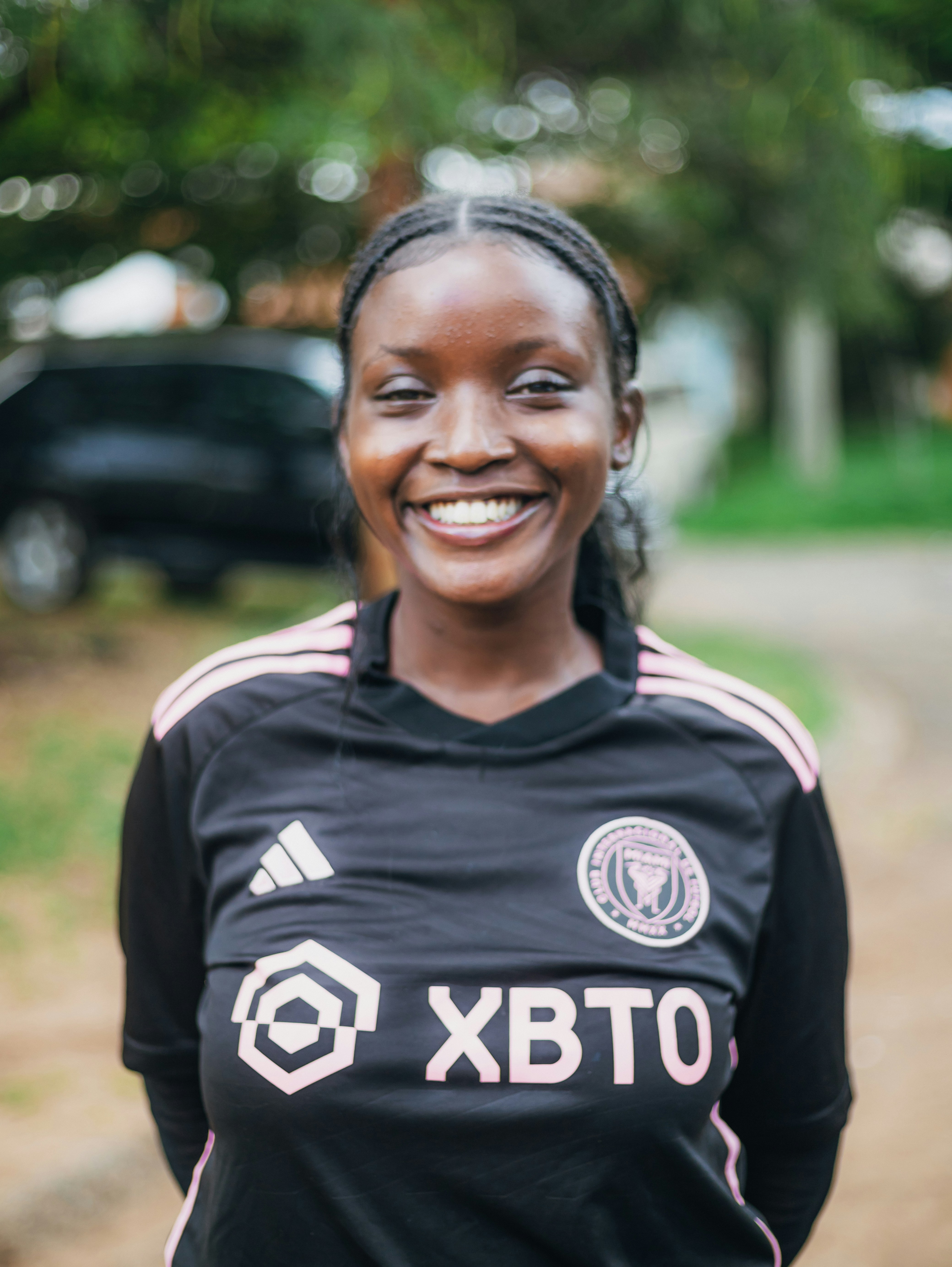 Bright Momentum: A smiling athlete in a black XBTO jersey