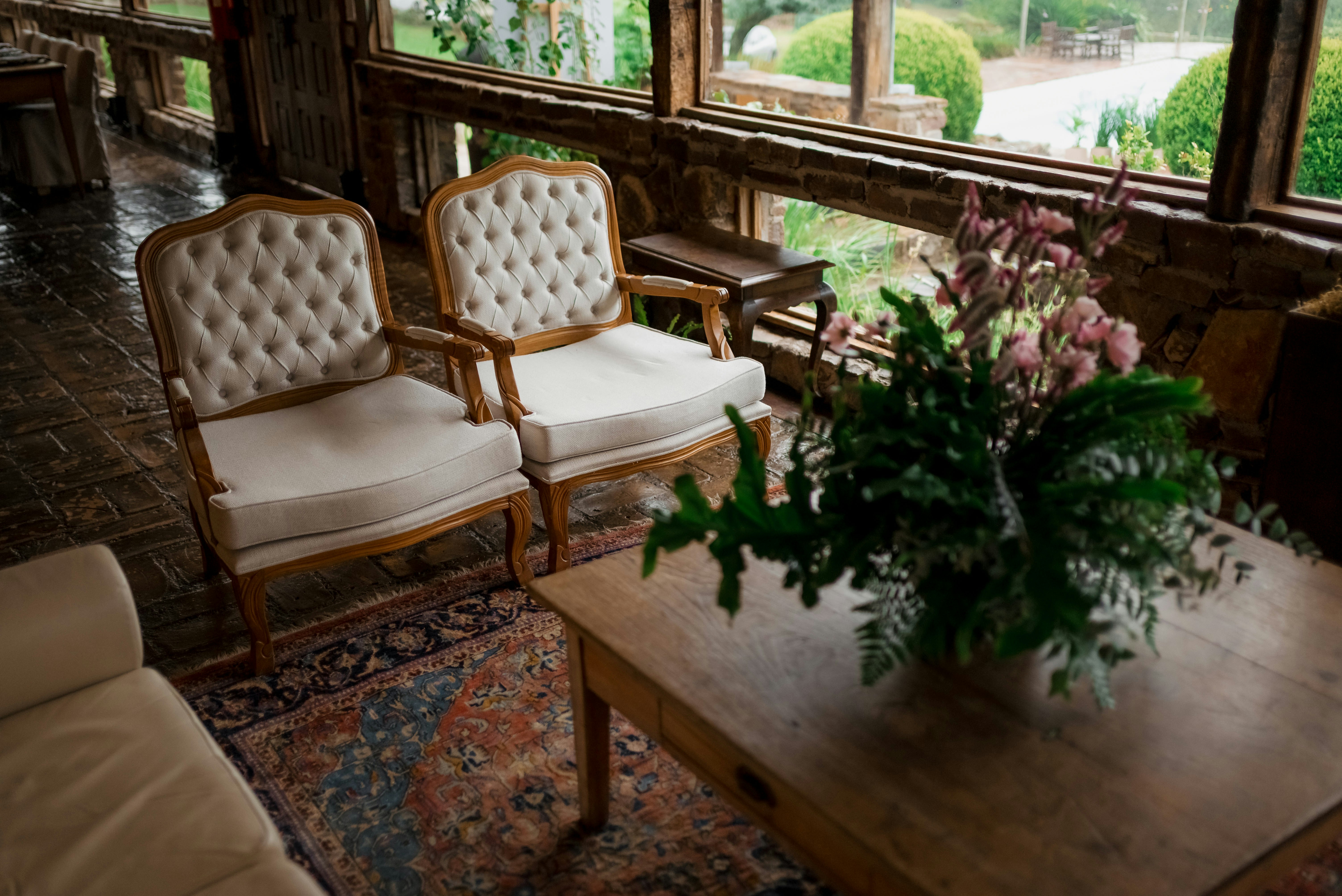 Sunlit Lounge: Vintage Chairs Framing a Flowering Table