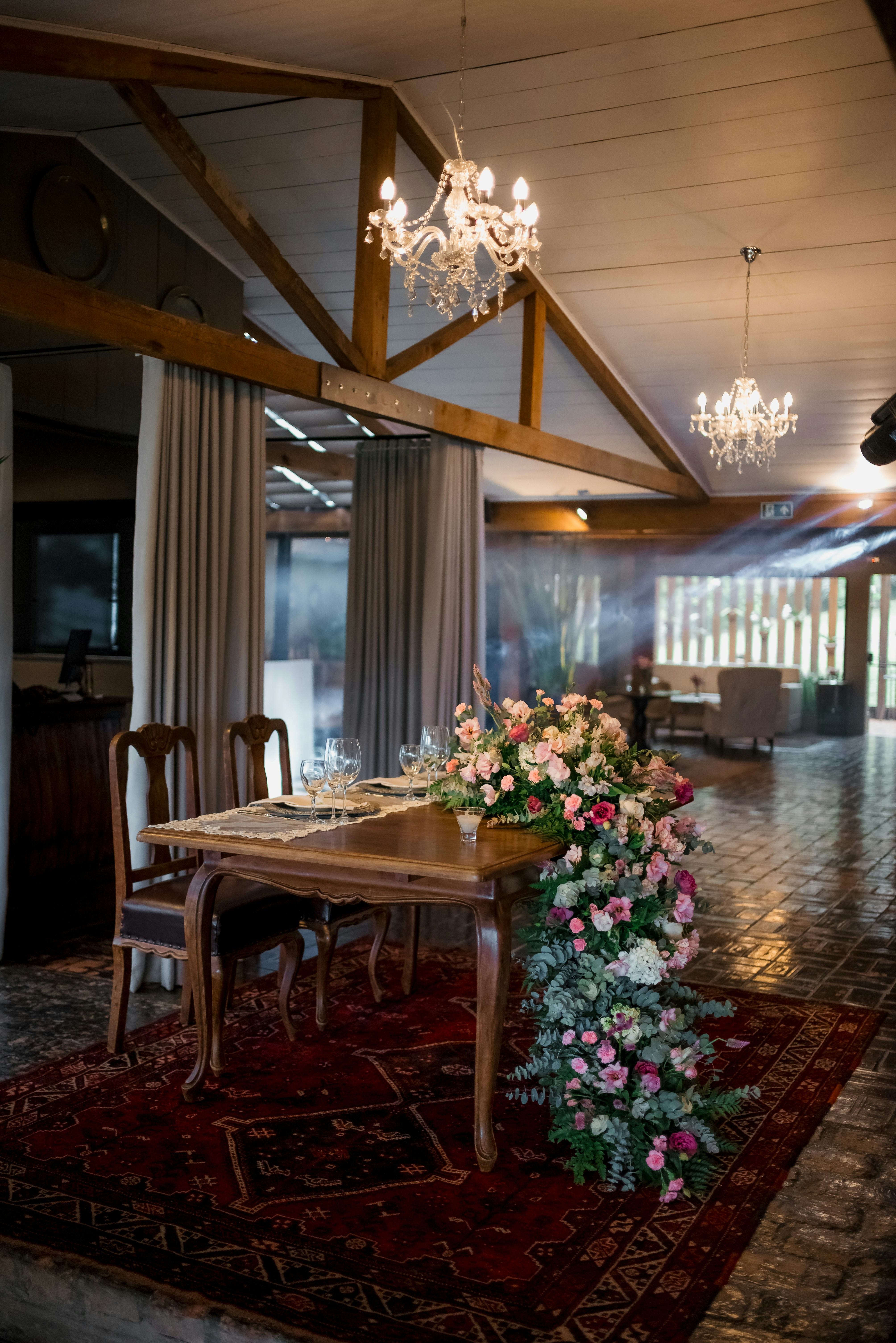 Elegant table for two with cascading floral arrangement.