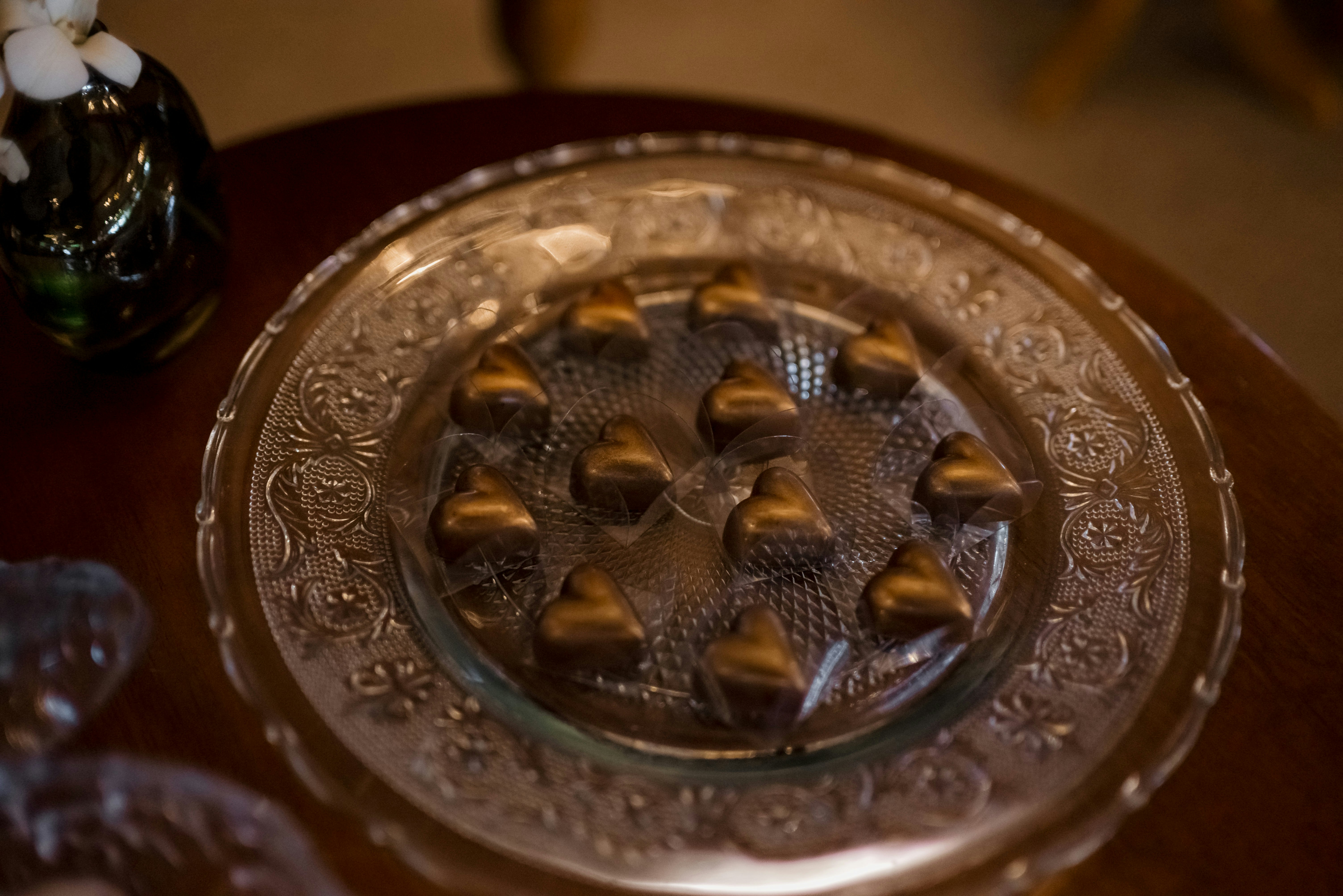 Decorative silver plate filled with heart-shaped chocolates.