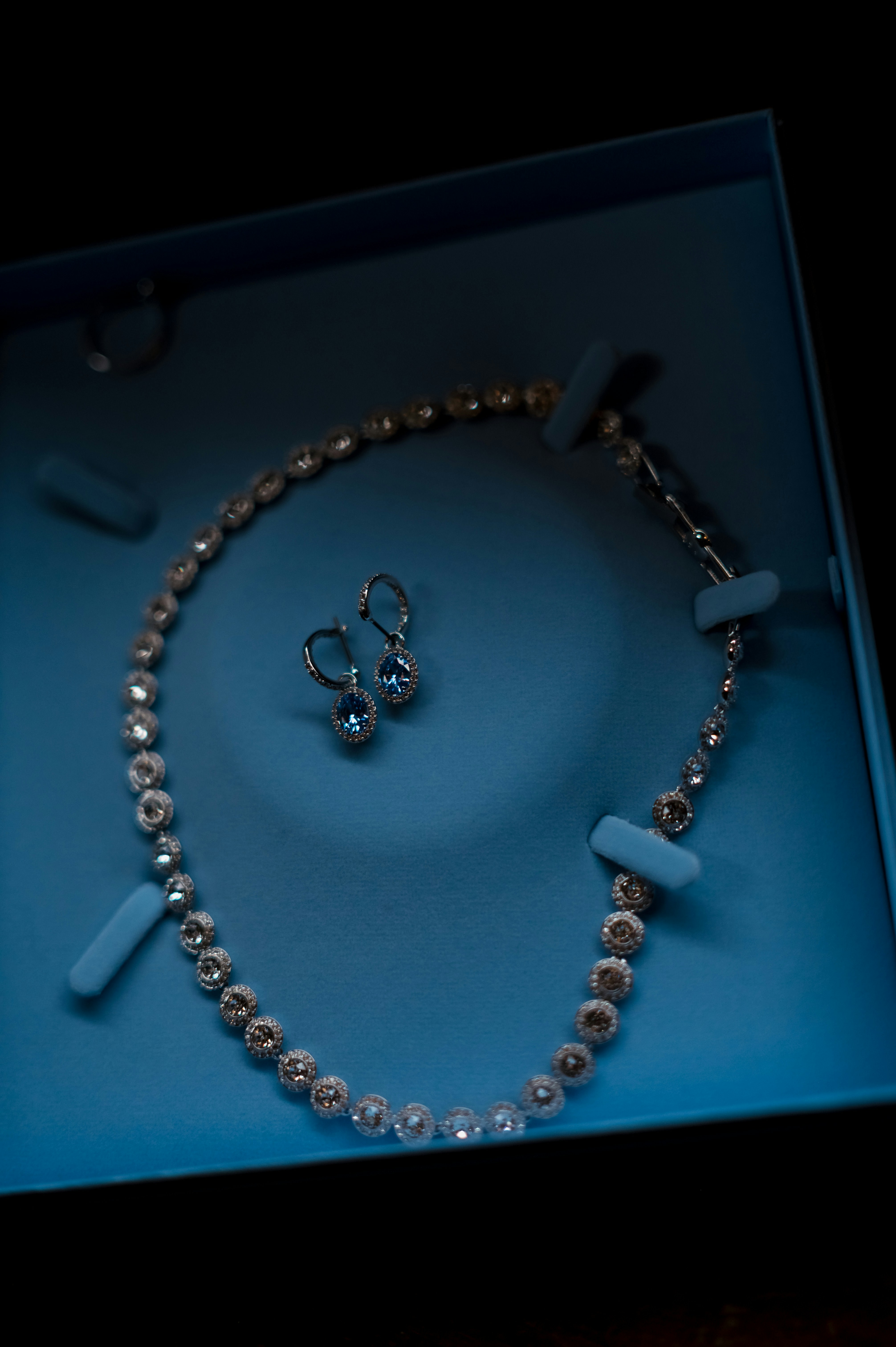 Blue Velvet Treasure: Diamond Necklace and Earrings in a Jewelry Box