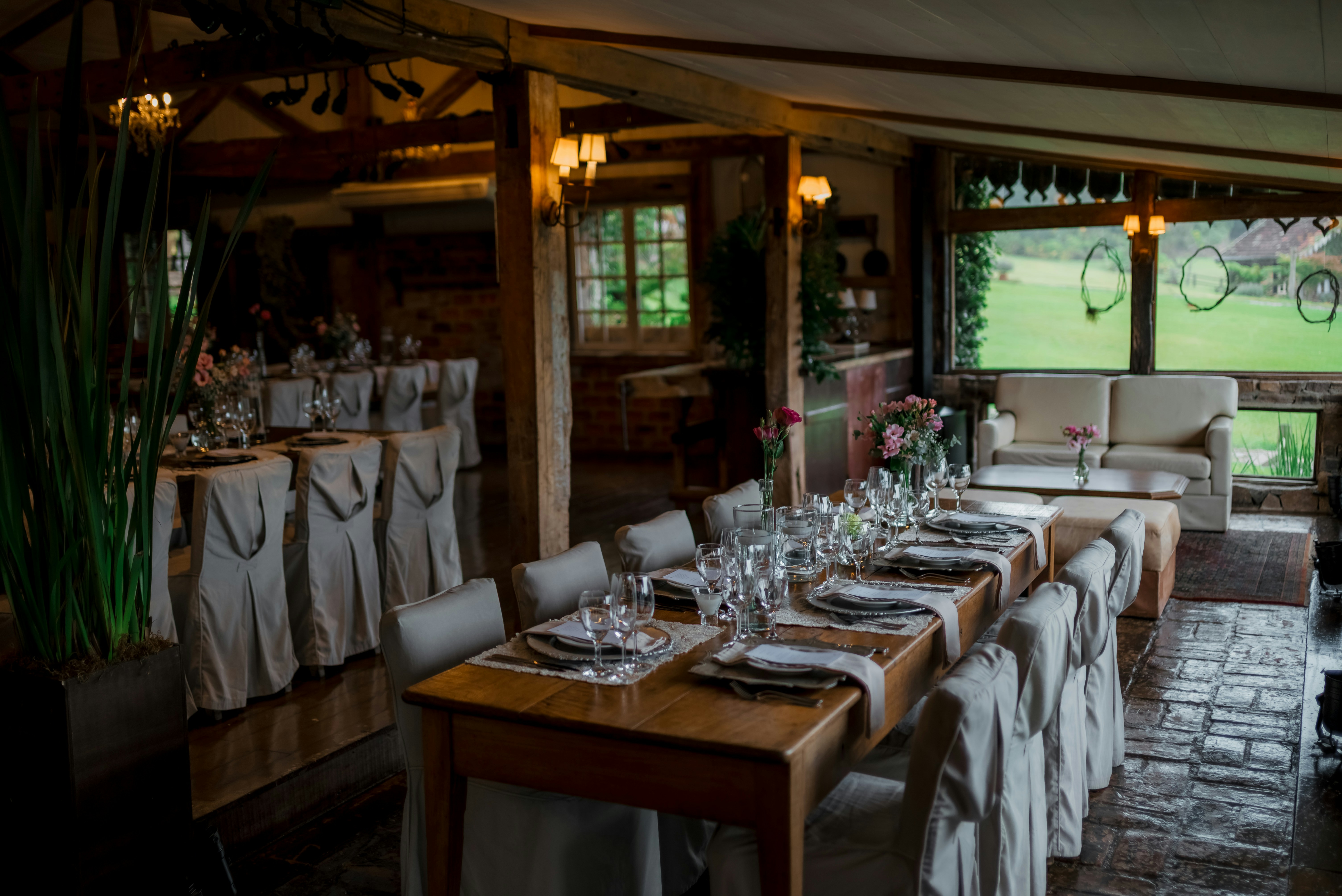 Elegant dining room with wooden tables and warm lighting.