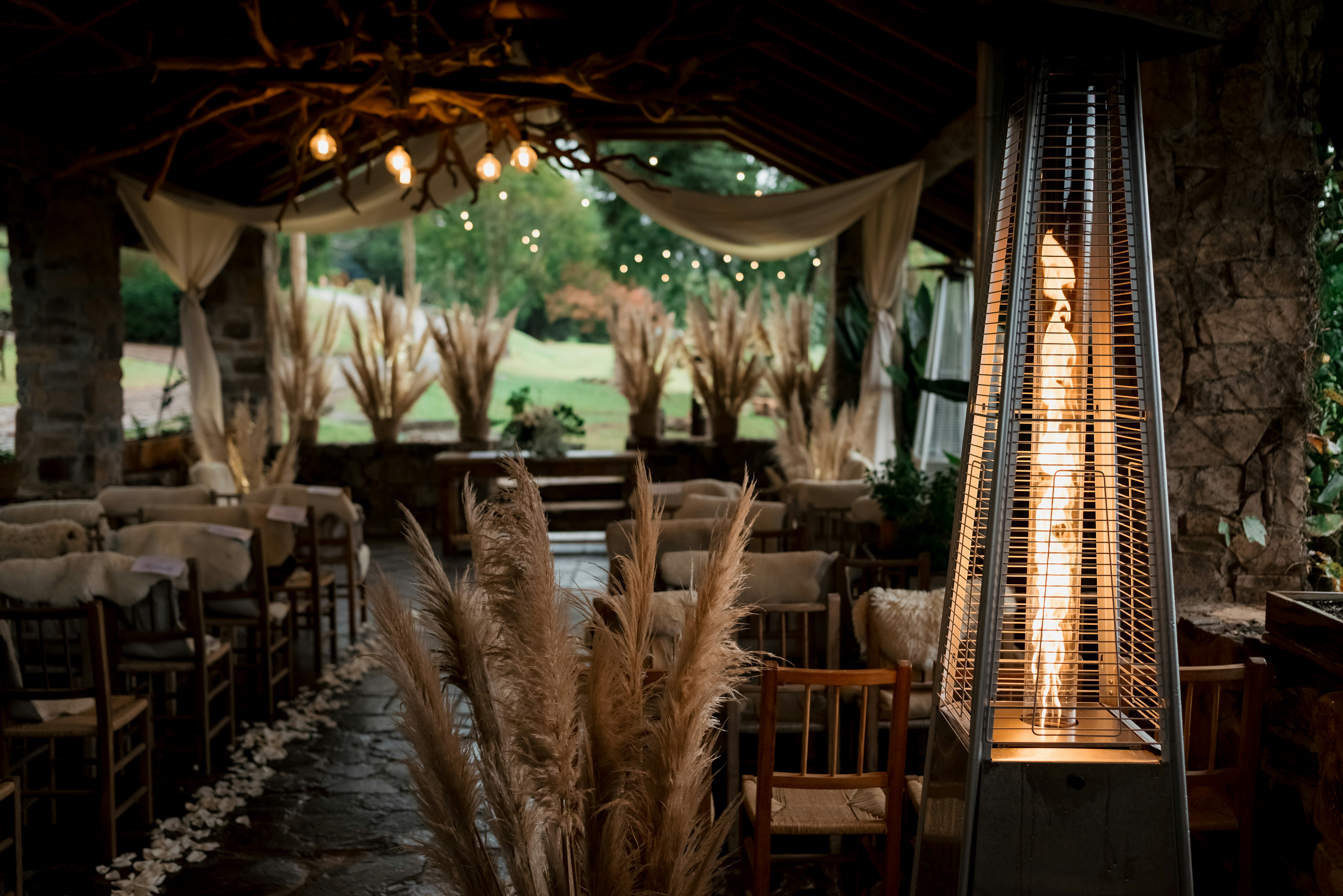 Warm Outdoor Reception Beneath Draped Canopies
