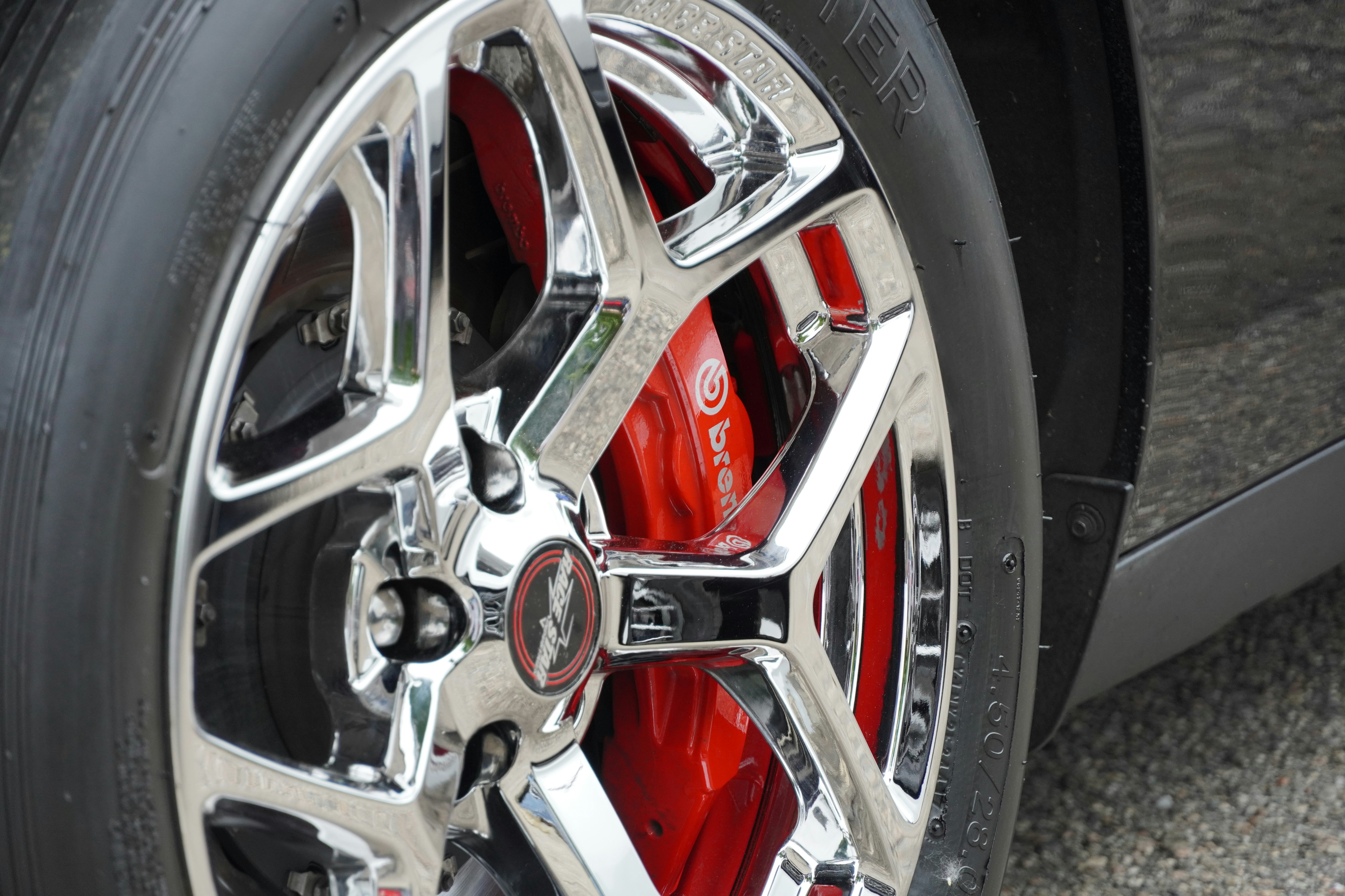 Chromed Spokes and Red Brake Calipers: A Close-Up on a Performance Wheel