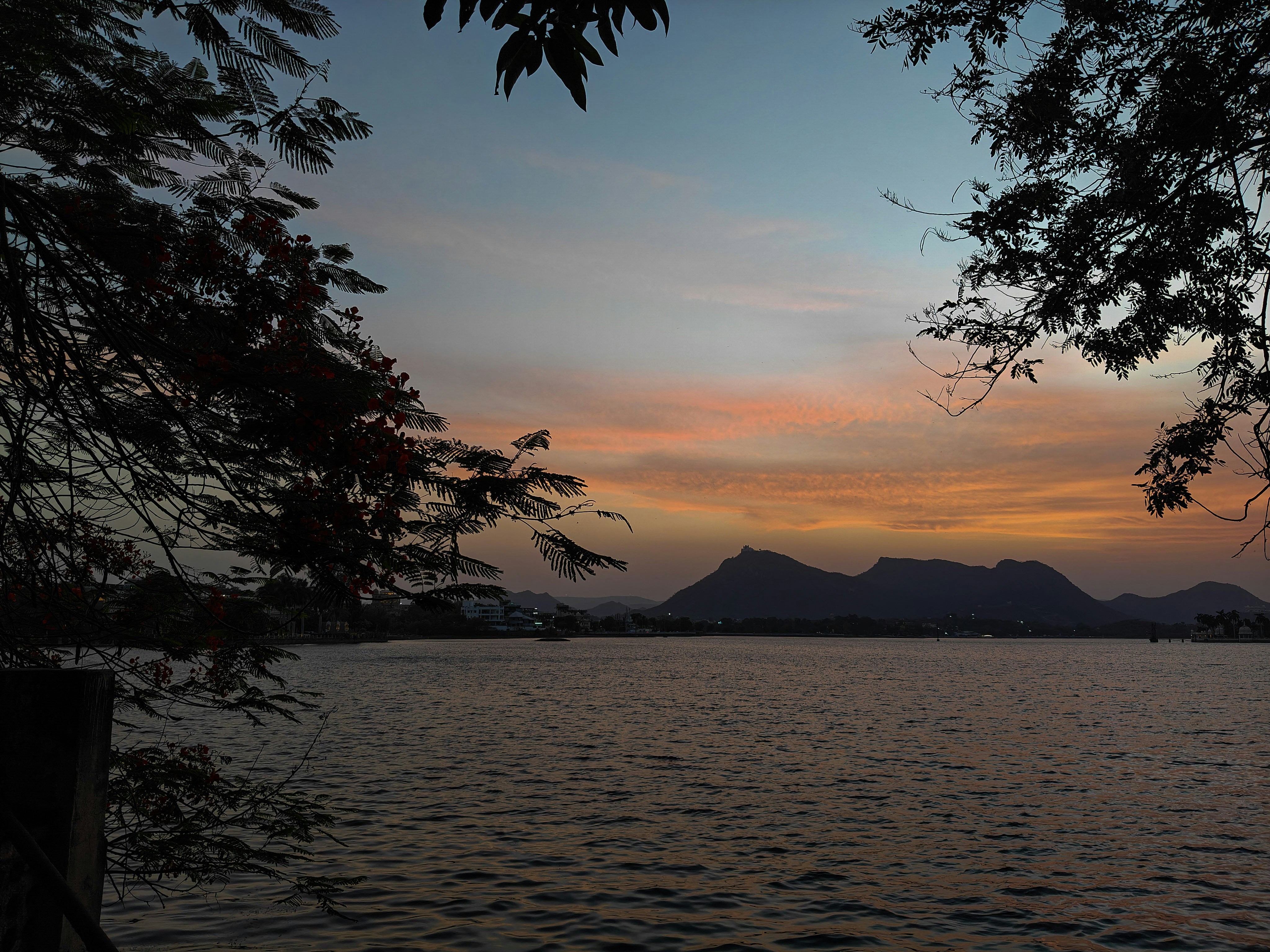 Sunset Silhouette Over Quiet Bay