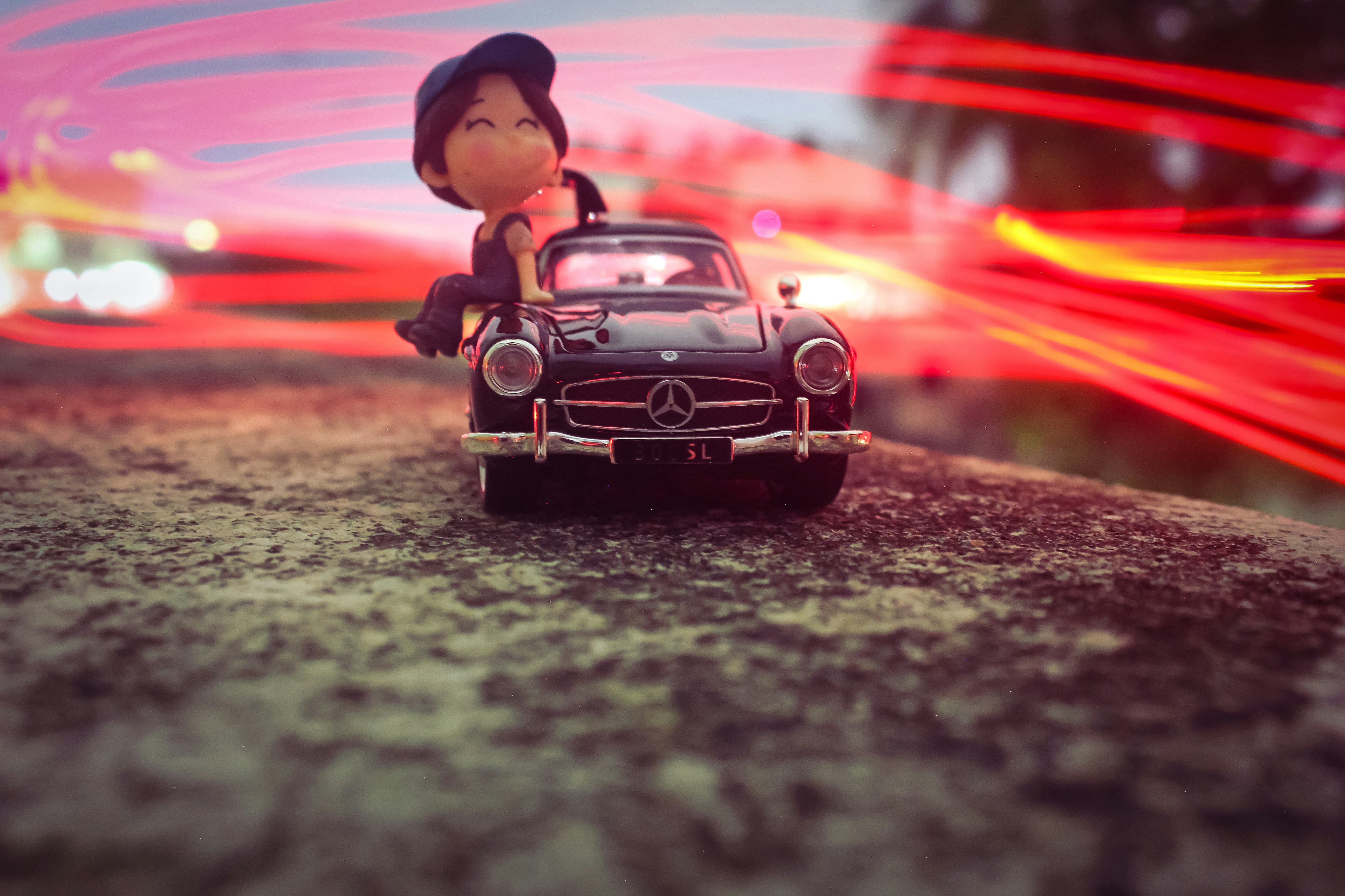 Toy Coaster: A Tiny Driver Basks in Neon Trails