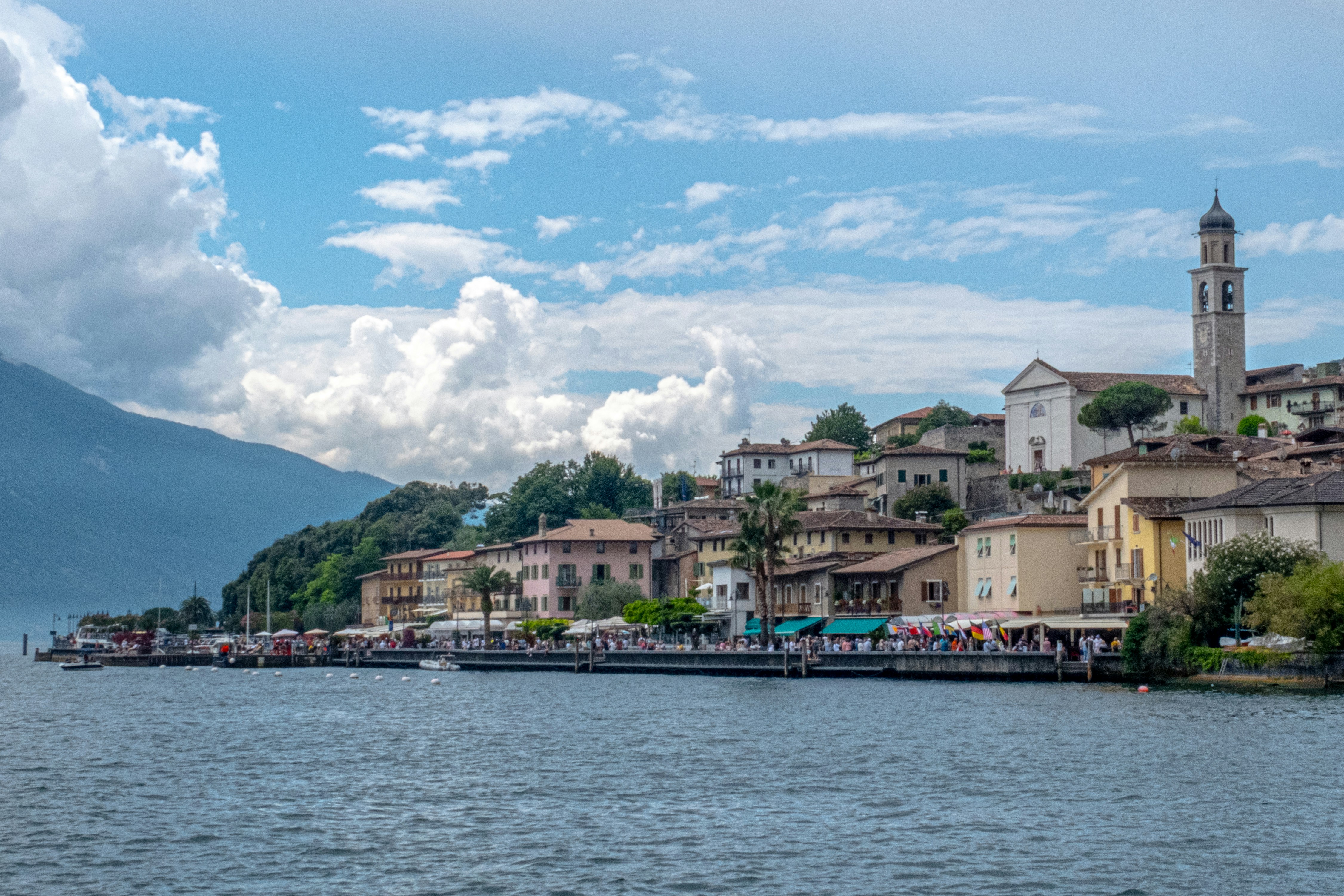 Picturesque town on a lake shore under a cloudy sky.