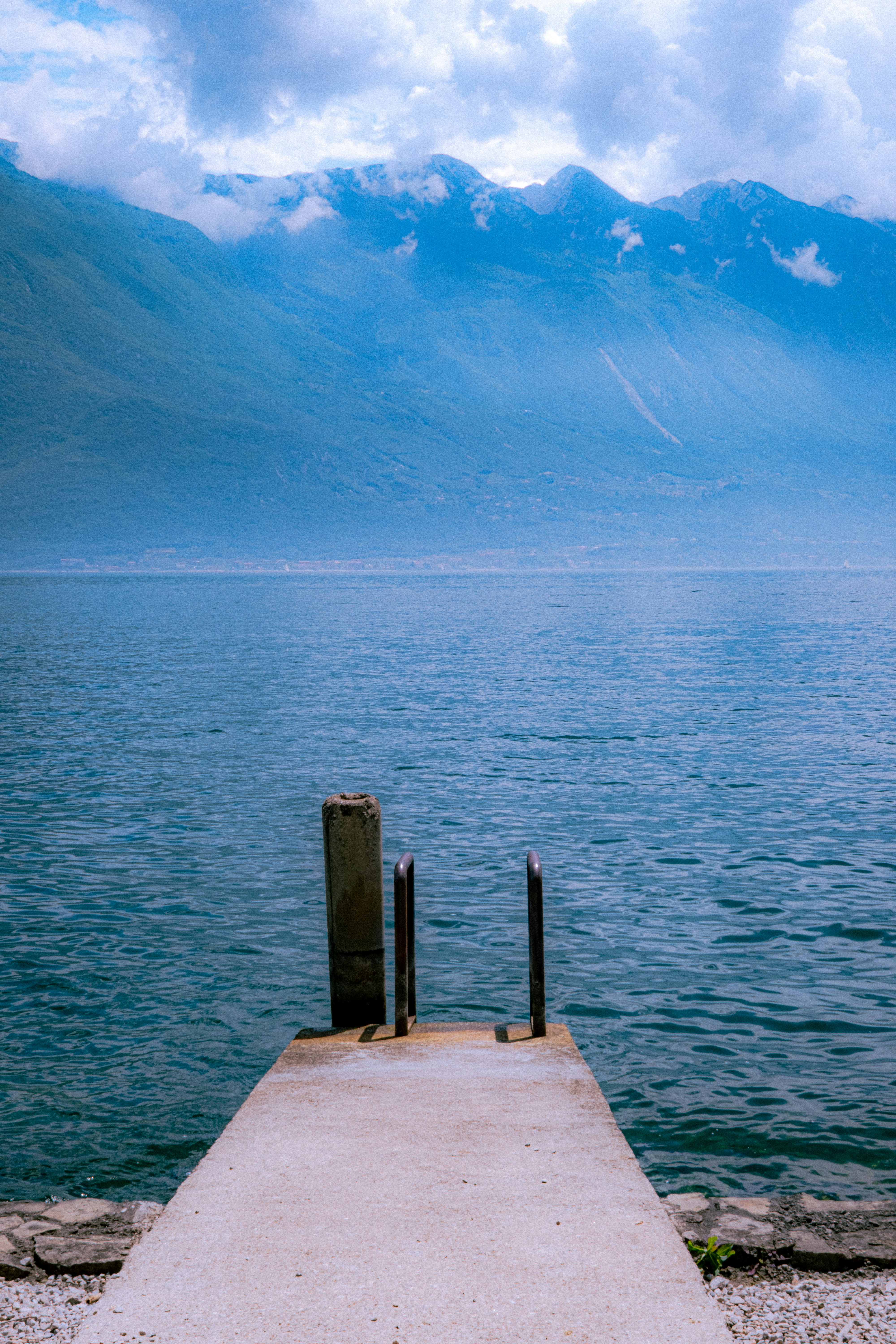 Dock into Blue Silence: A Quiet Pier Reaching Toward Mountain Mist