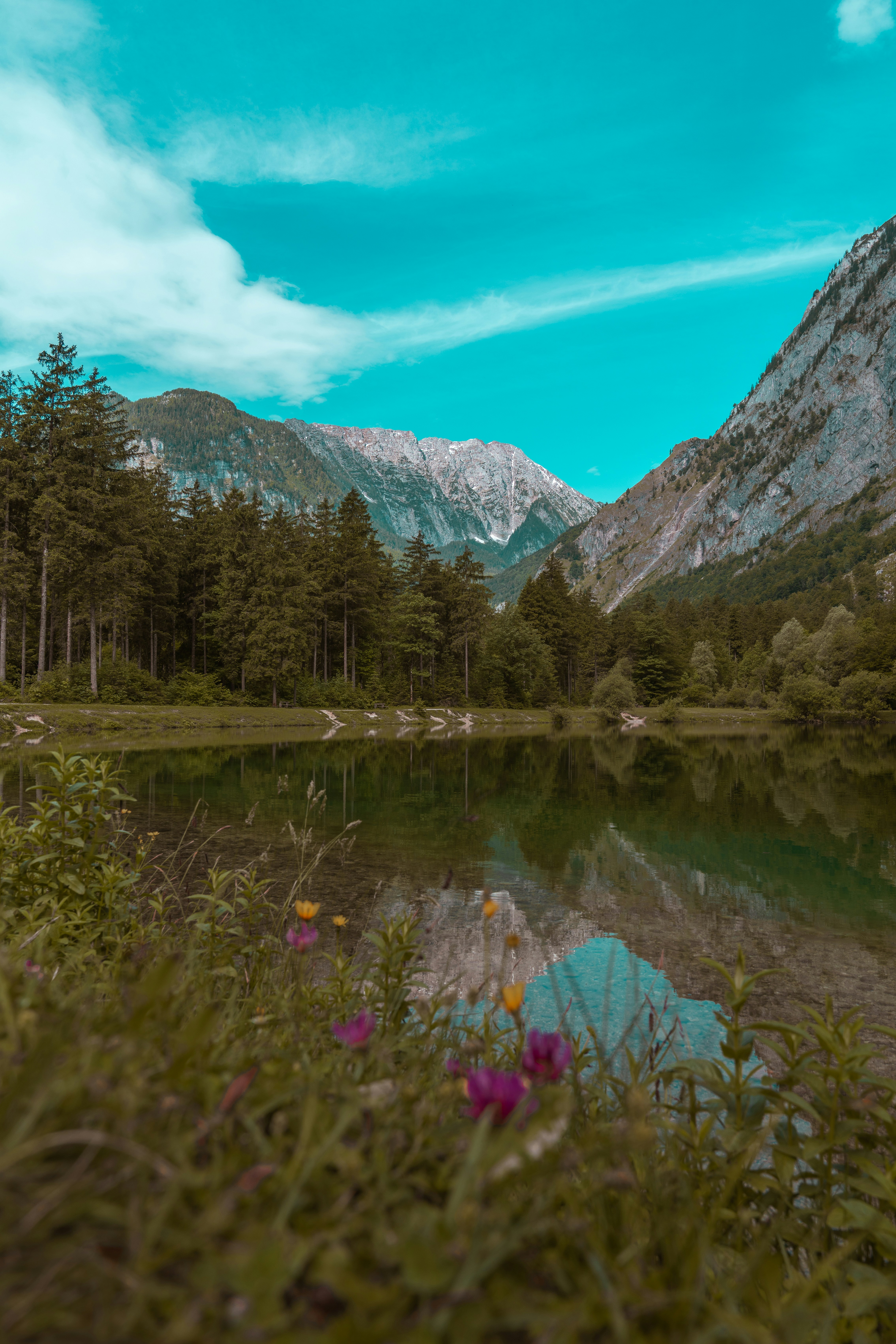 Mirror of Peaks: Alpine Lake Beneath a Cyan Sky