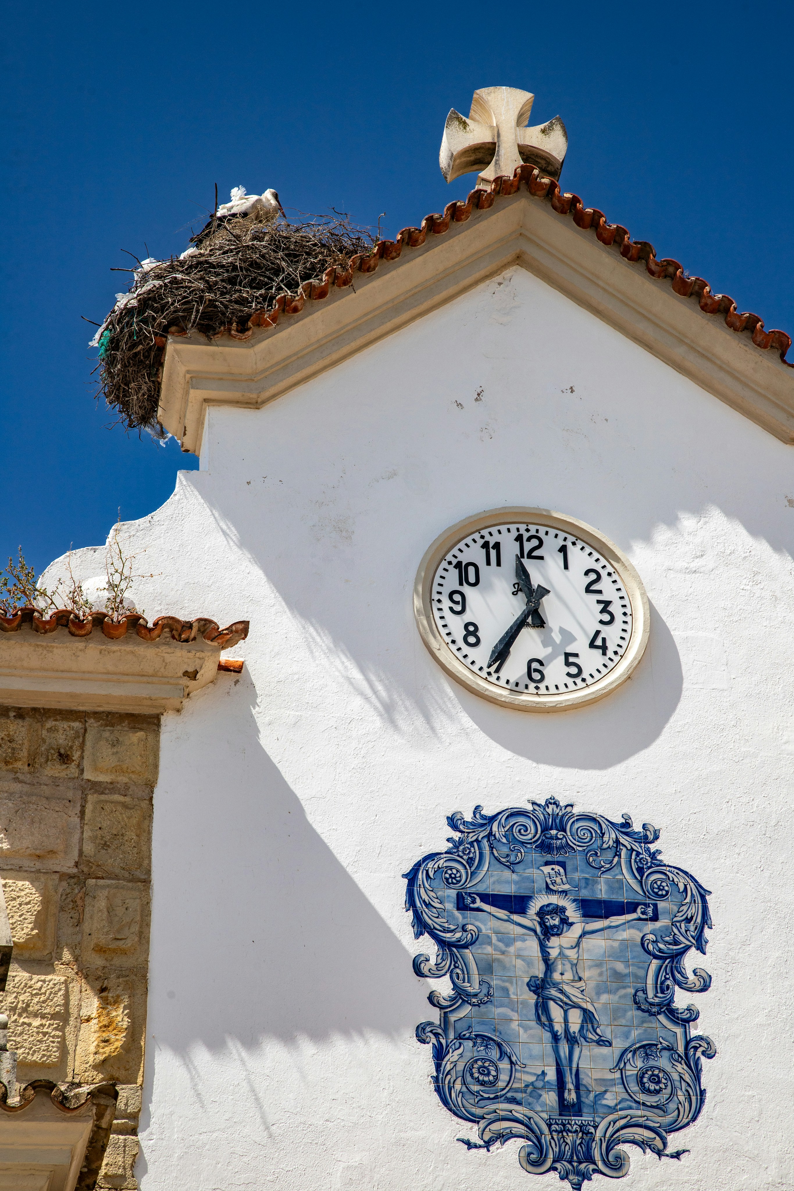 Staircase of Time: A Clock on a Sunlit Facade