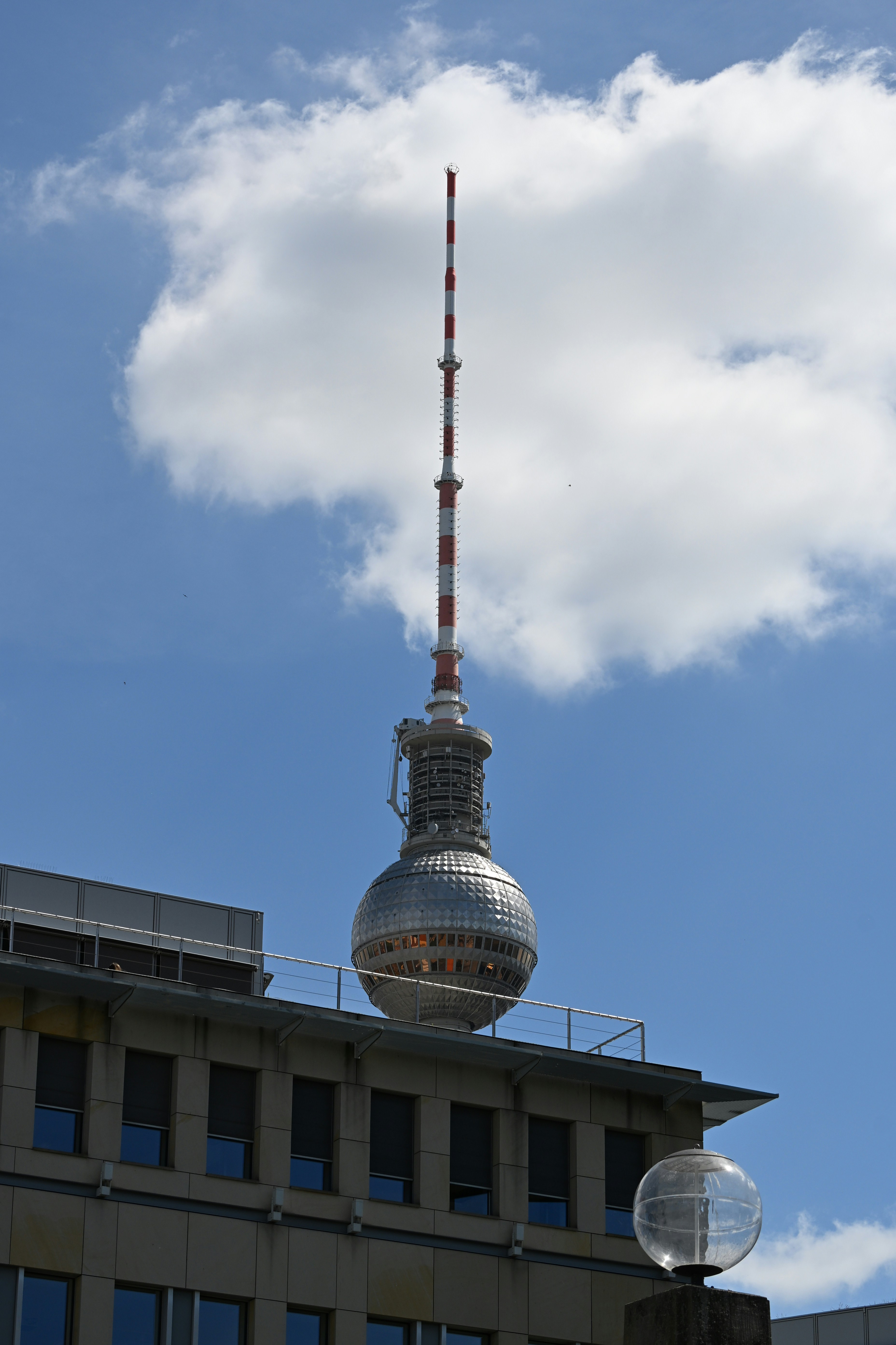 Antenna Spire Piercing the Sky Above the Facade