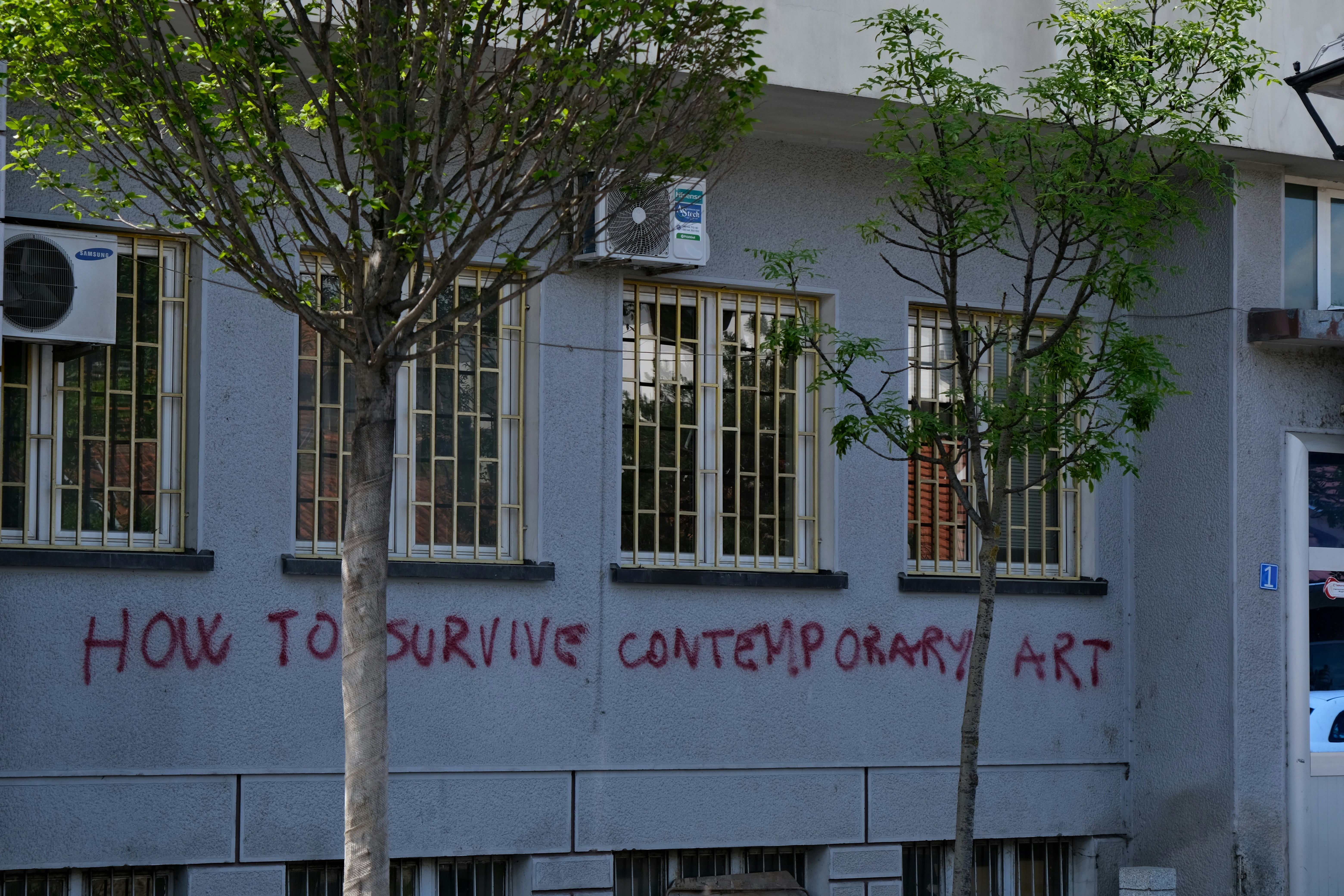 Graffiti Message Under a Quiet City Window