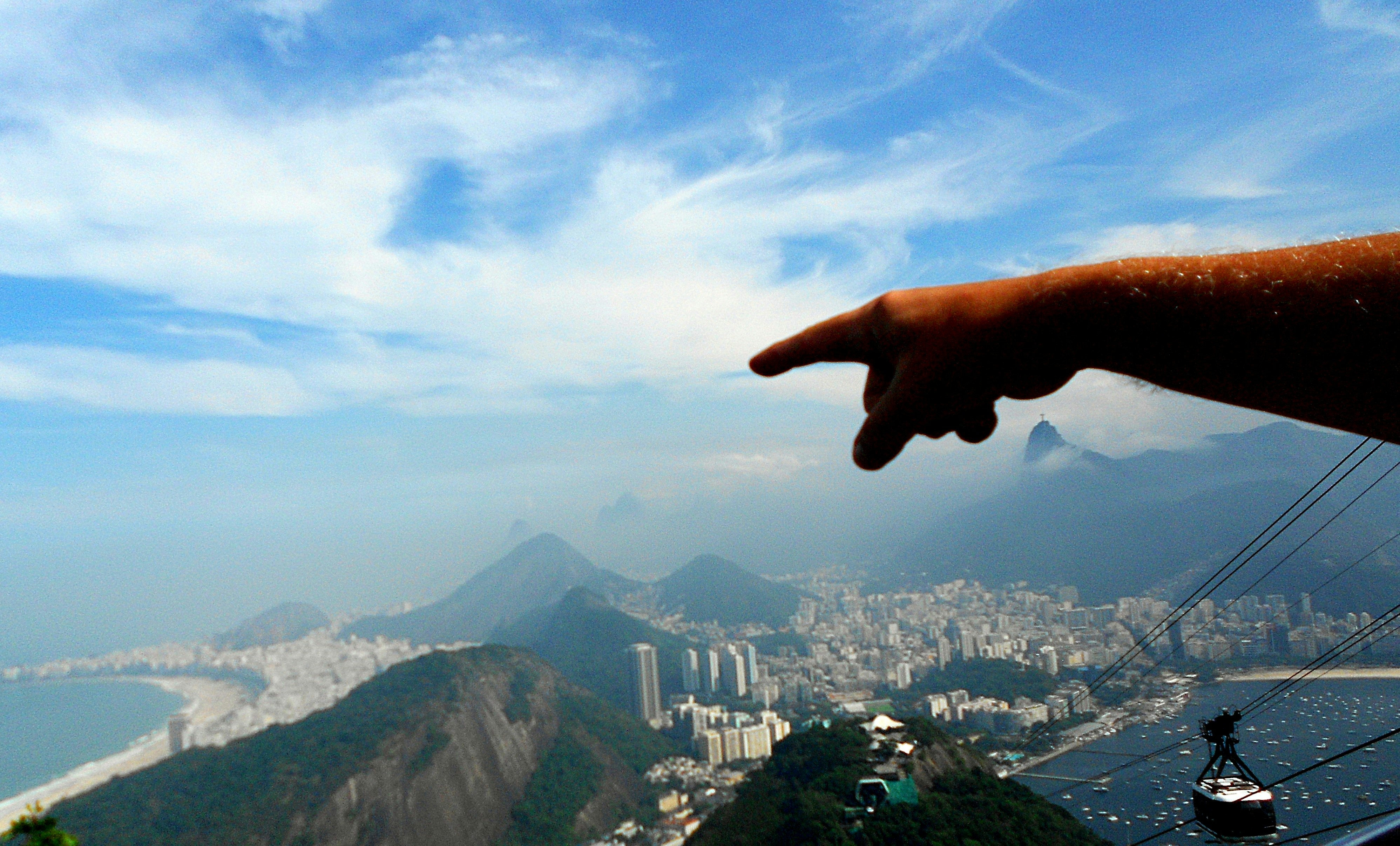 Skyline Grasp: A Distant Hand Points Over Rio’s Hangout