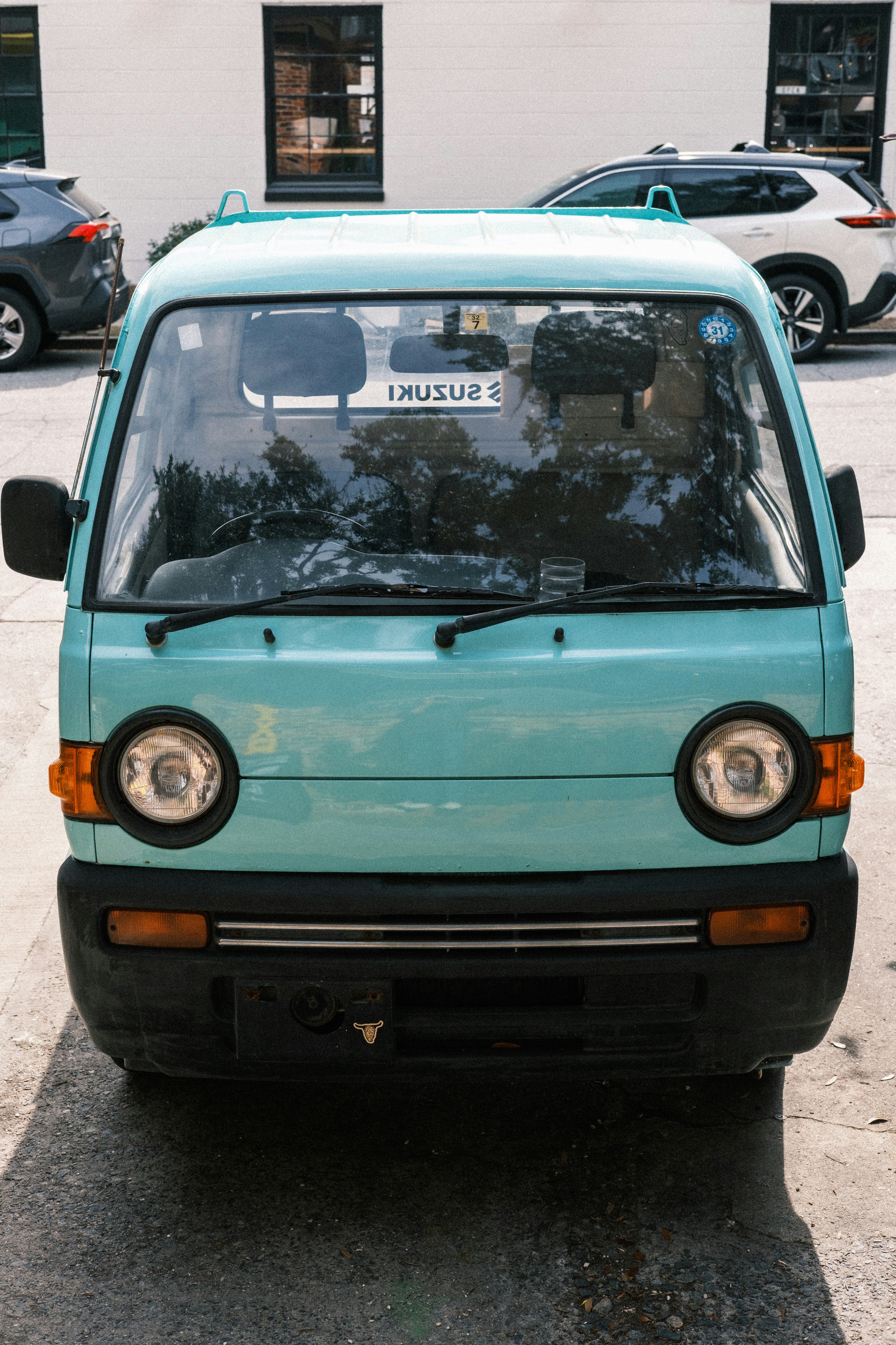 Minty Mini: Front-facing Charm of a Teal Microvan