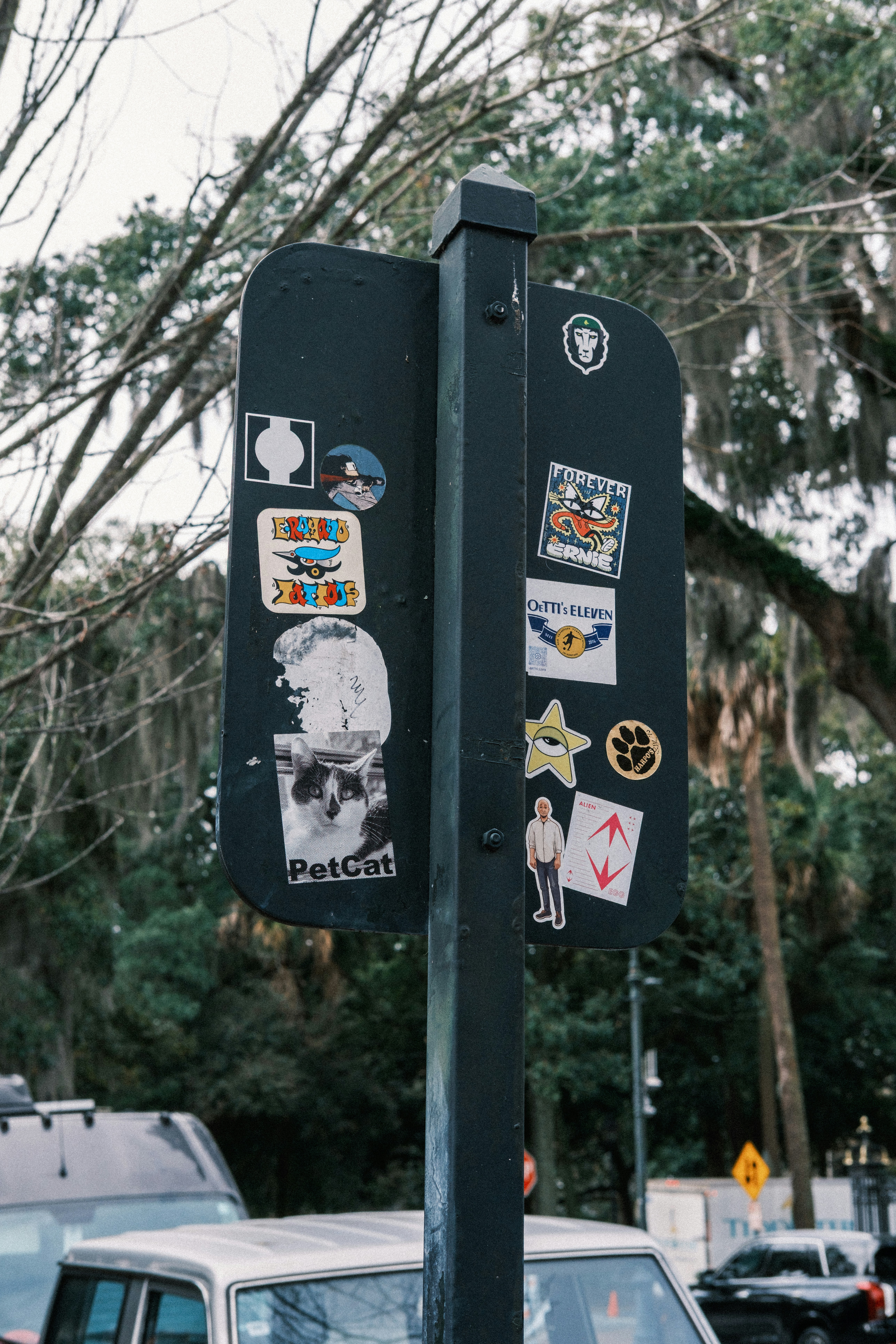 Stickered Signpost in a Quiet Parking Zone