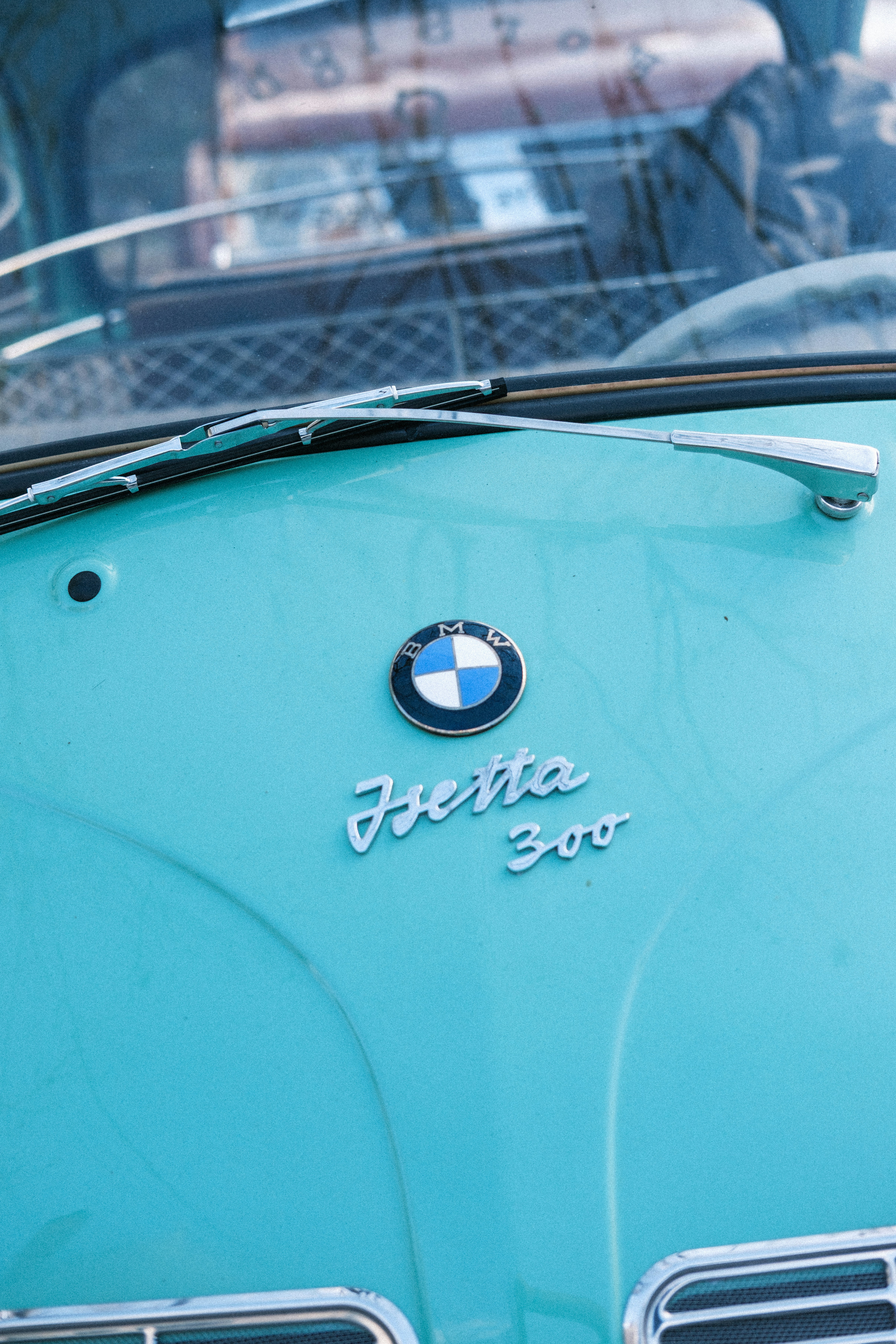 Turquoise Vintage: BMW Isetta Hood and Emblem in Focus