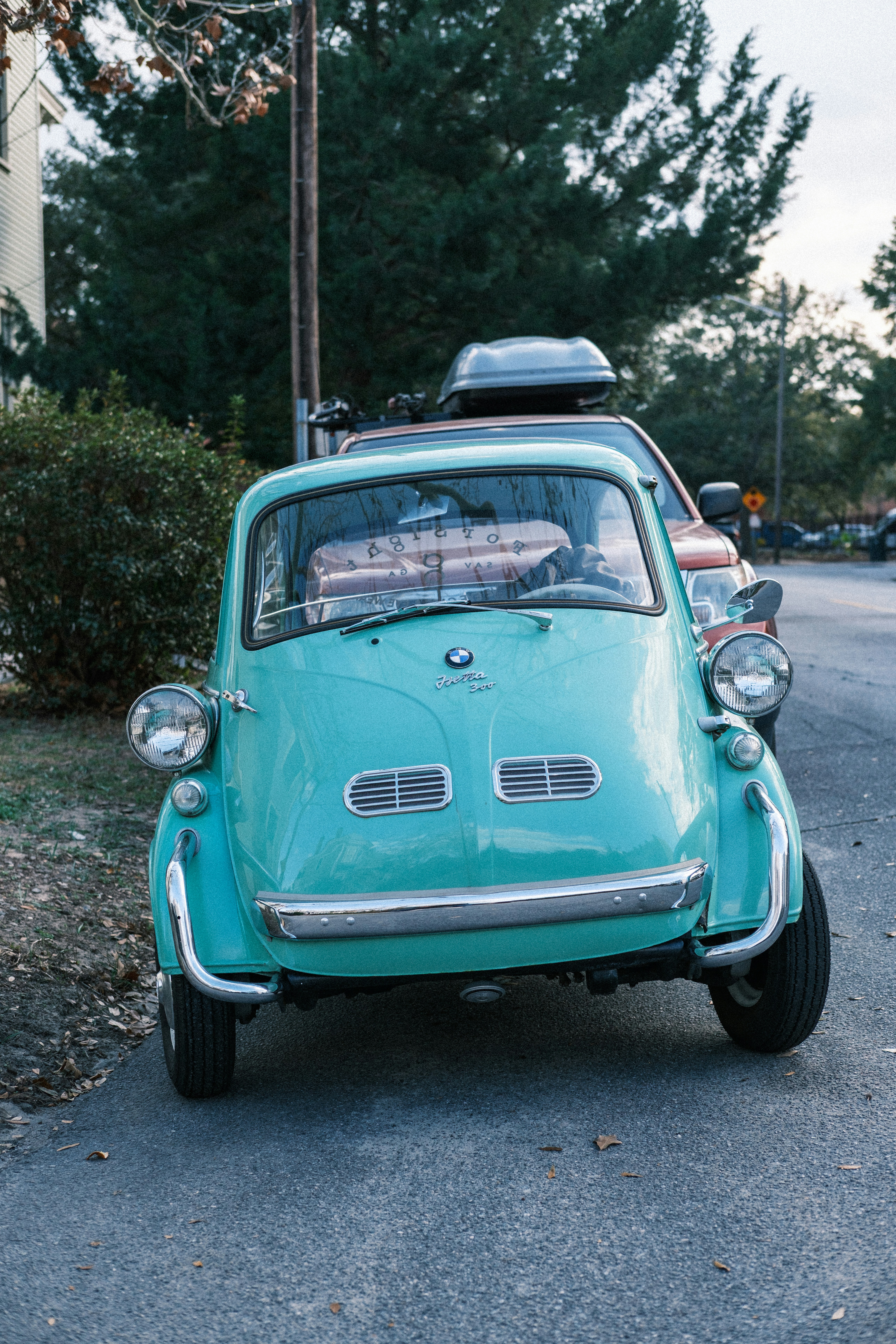Minty time capsule: a vintage BMW Isetta tucked into a quiet street