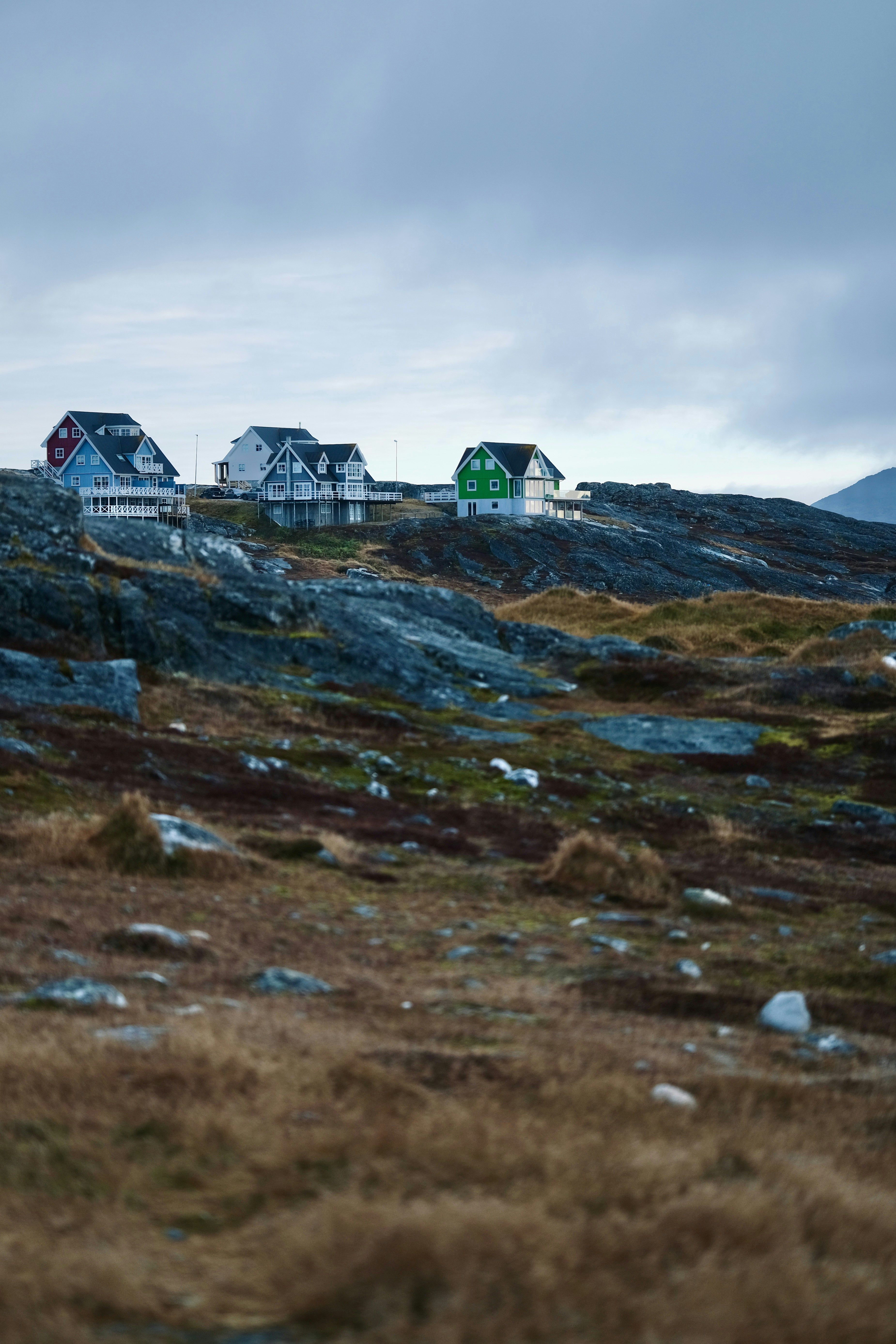 Colorful Coastal Cabins Rising Above Rugged Terrain