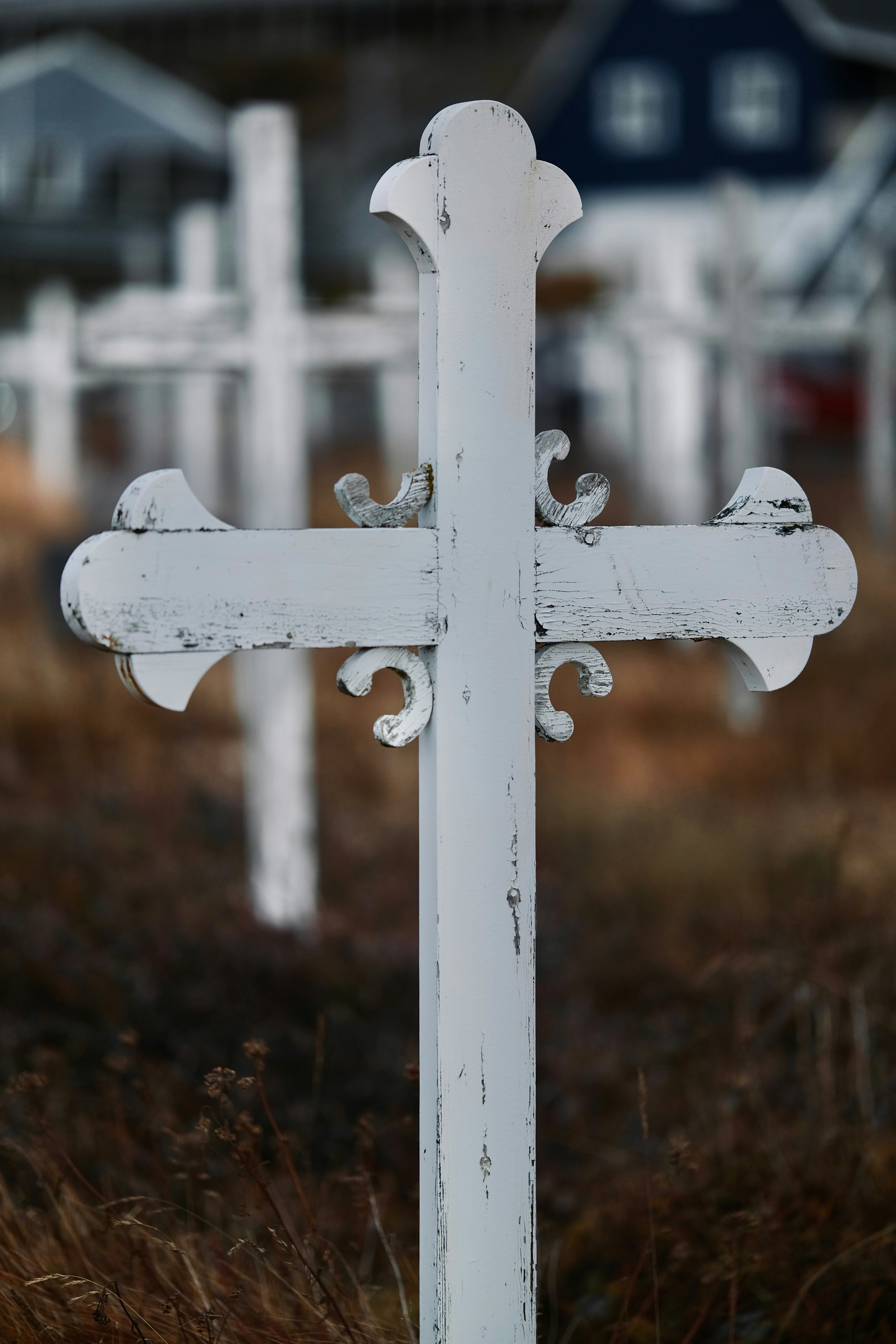 Weathered White Cross in a Quiet Yard