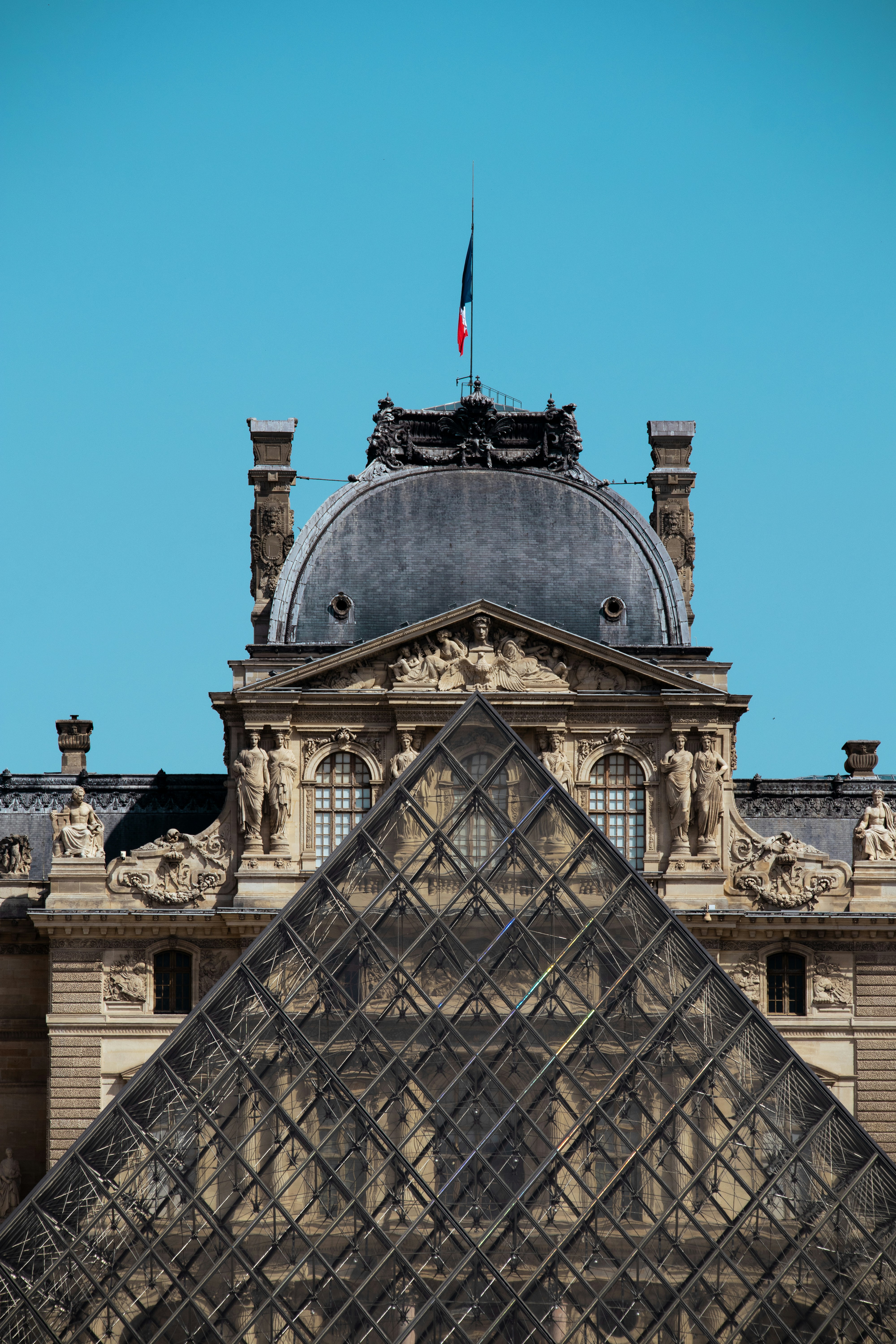 Symmetry and Glass: The Louvre Pyramid Framing a Classic Facade