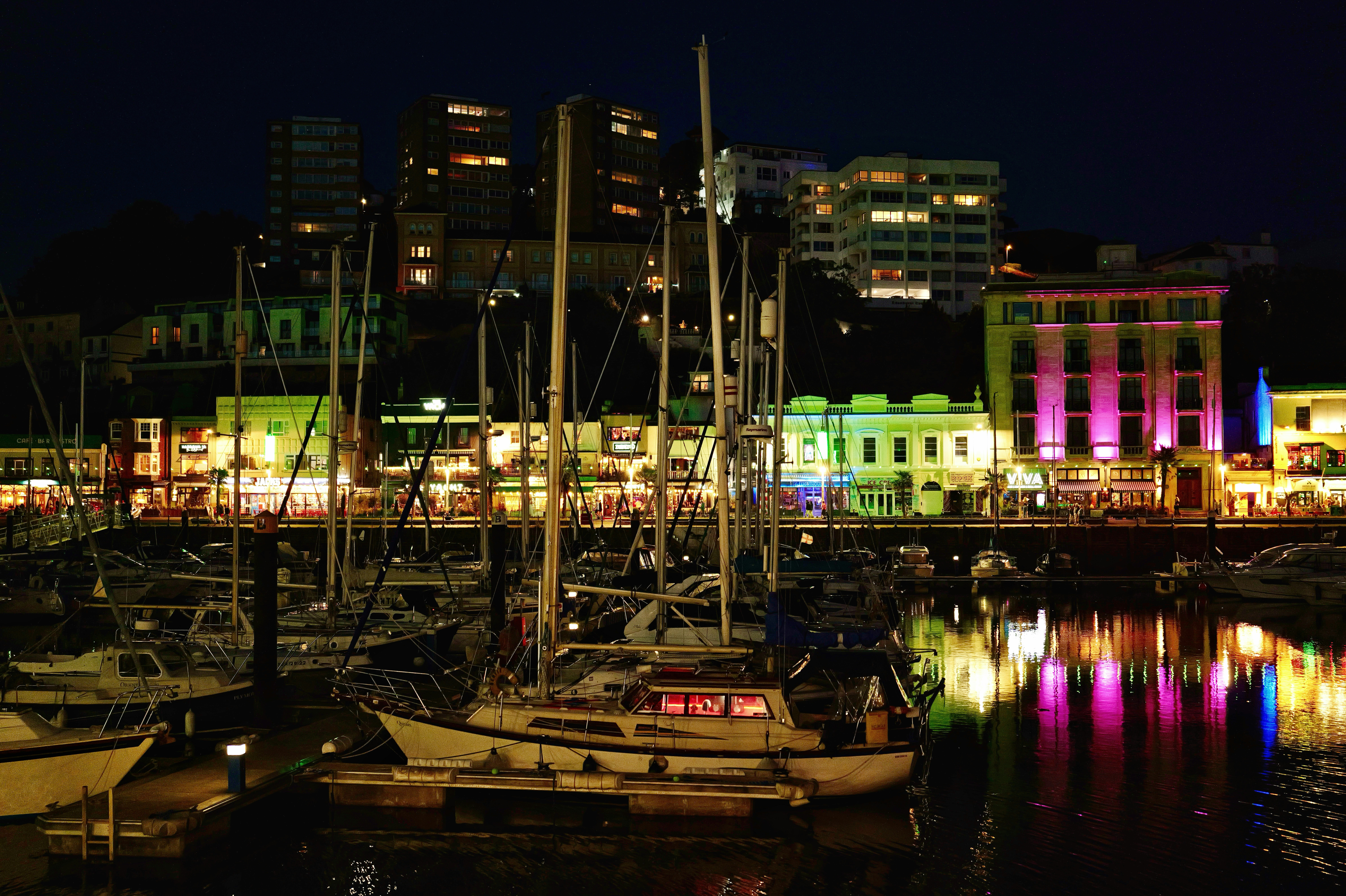 Neon Harbor Reflections: Boats and Waterfront Lights at Night