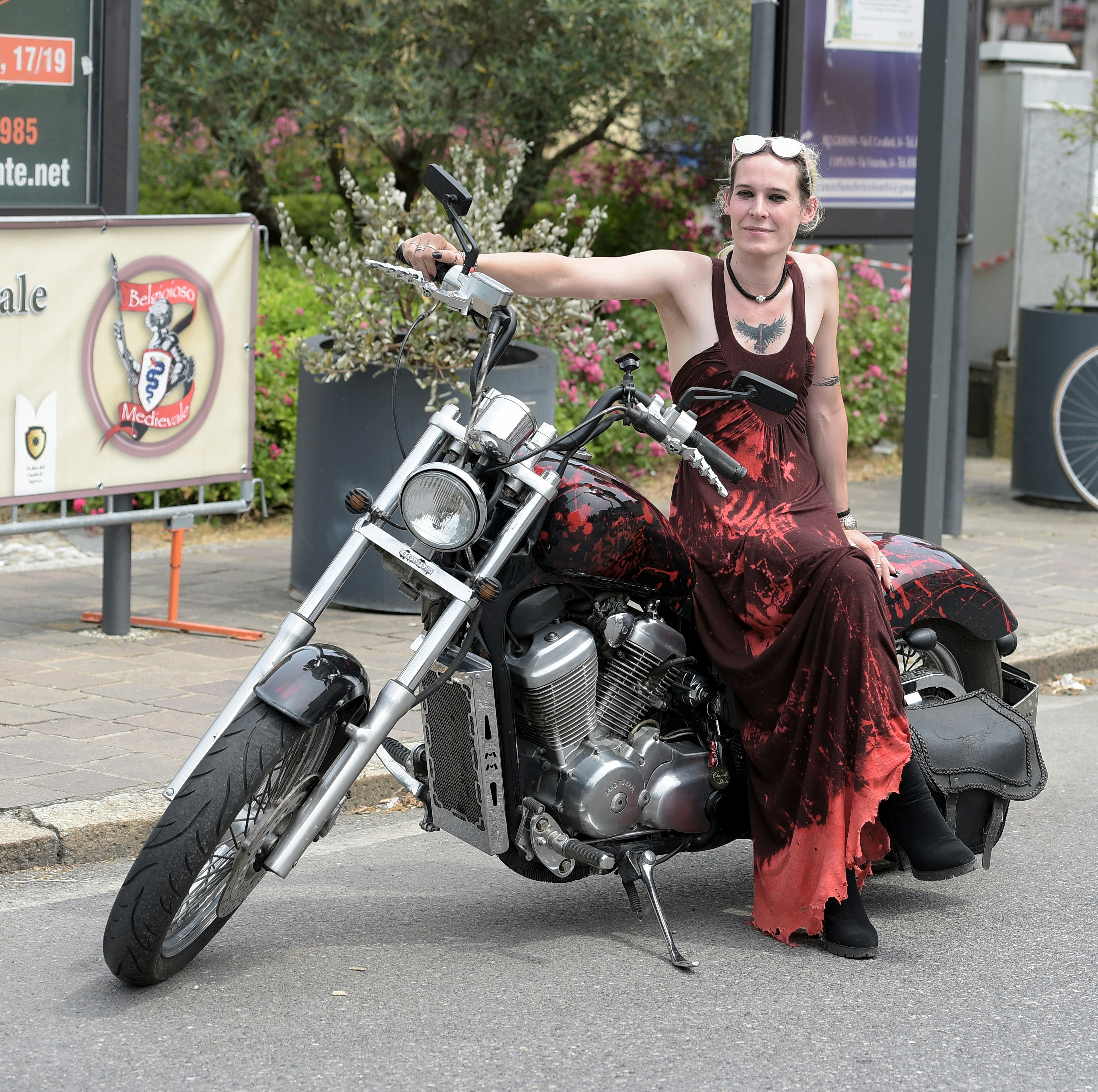 Leather-wheeled Daydream: A Rider in Red at the Street Corner