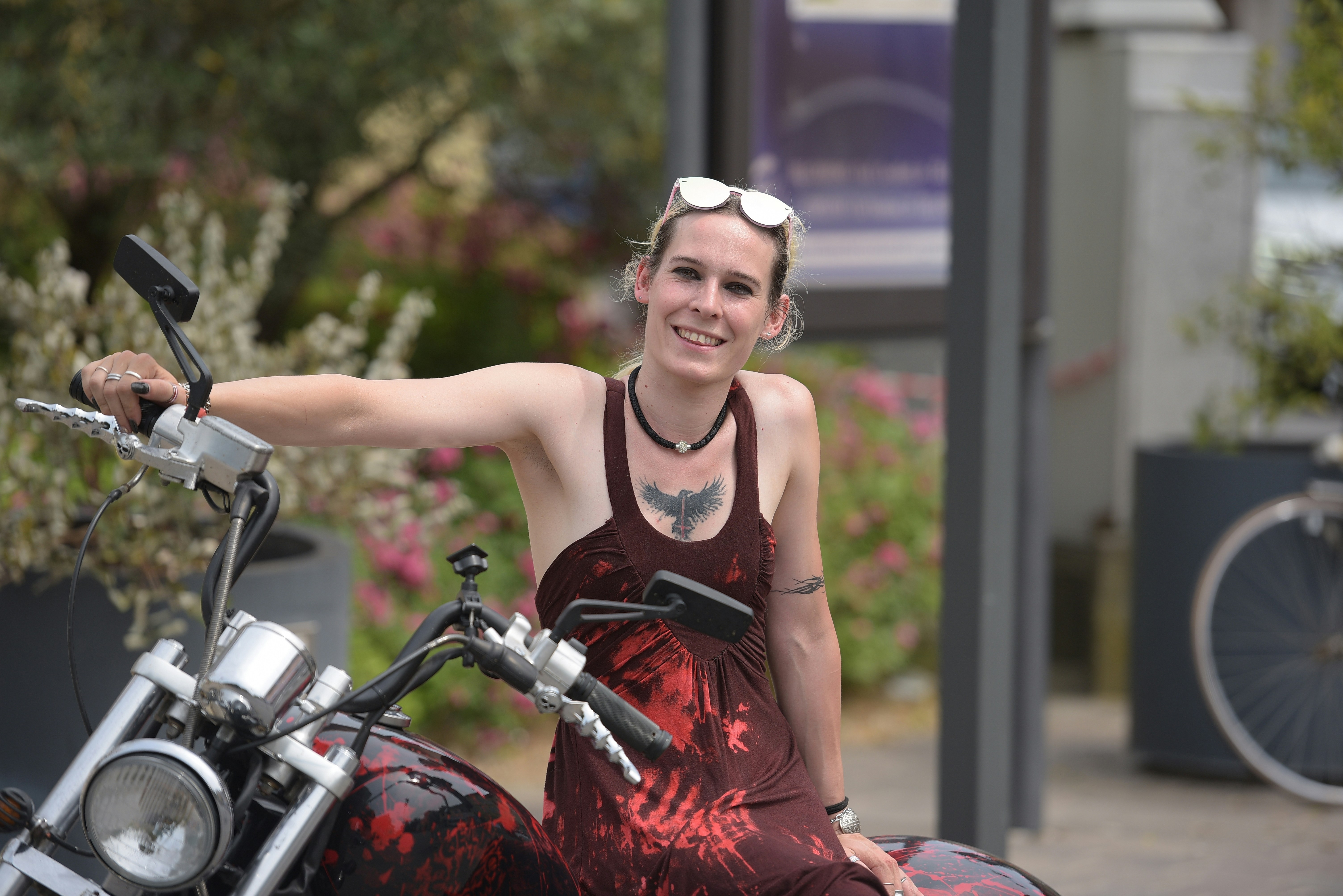 Smiling Rider in a Red Dress on a Chrome Motorcycle