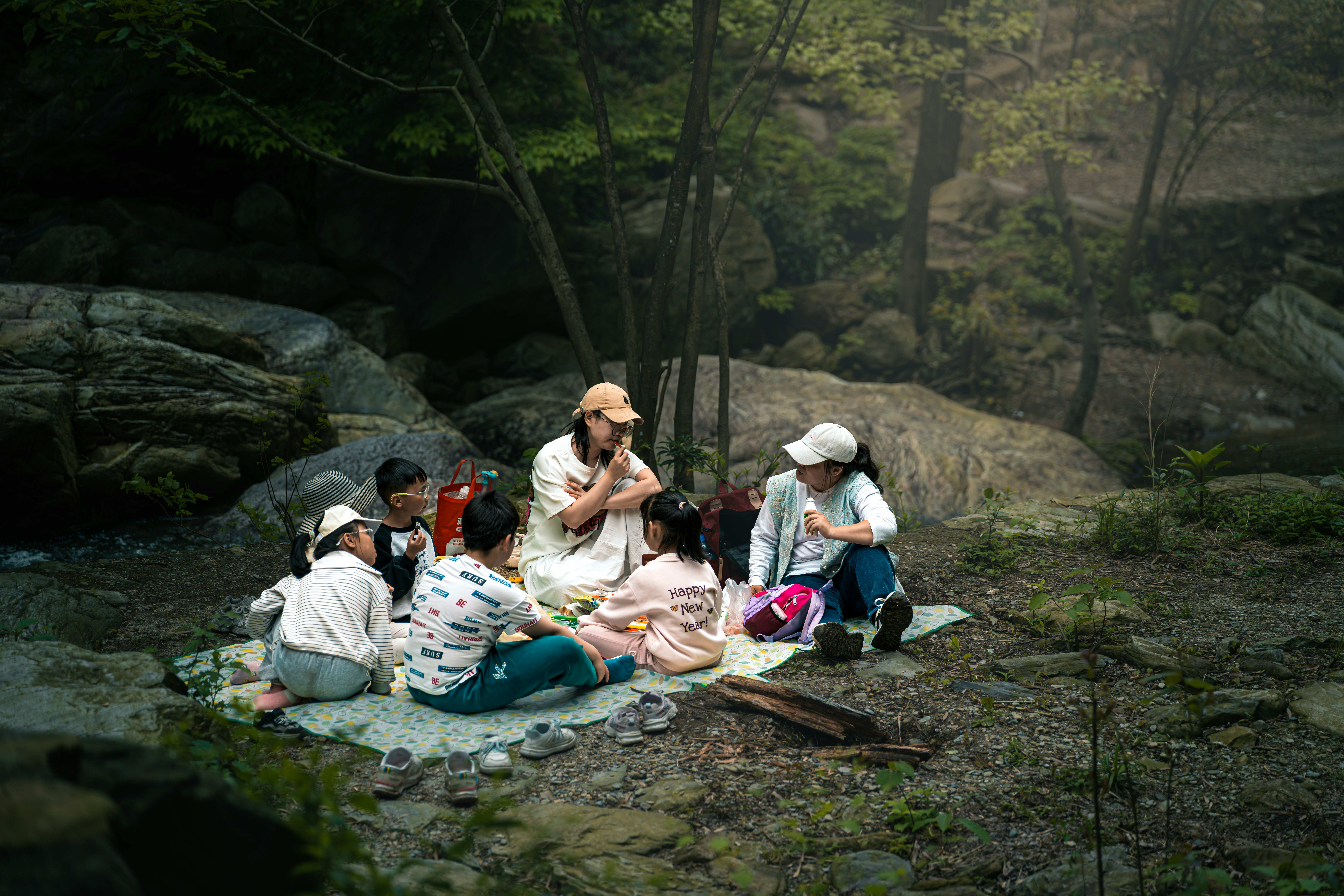 Group of Friends Around a Riverside Campfire Circle