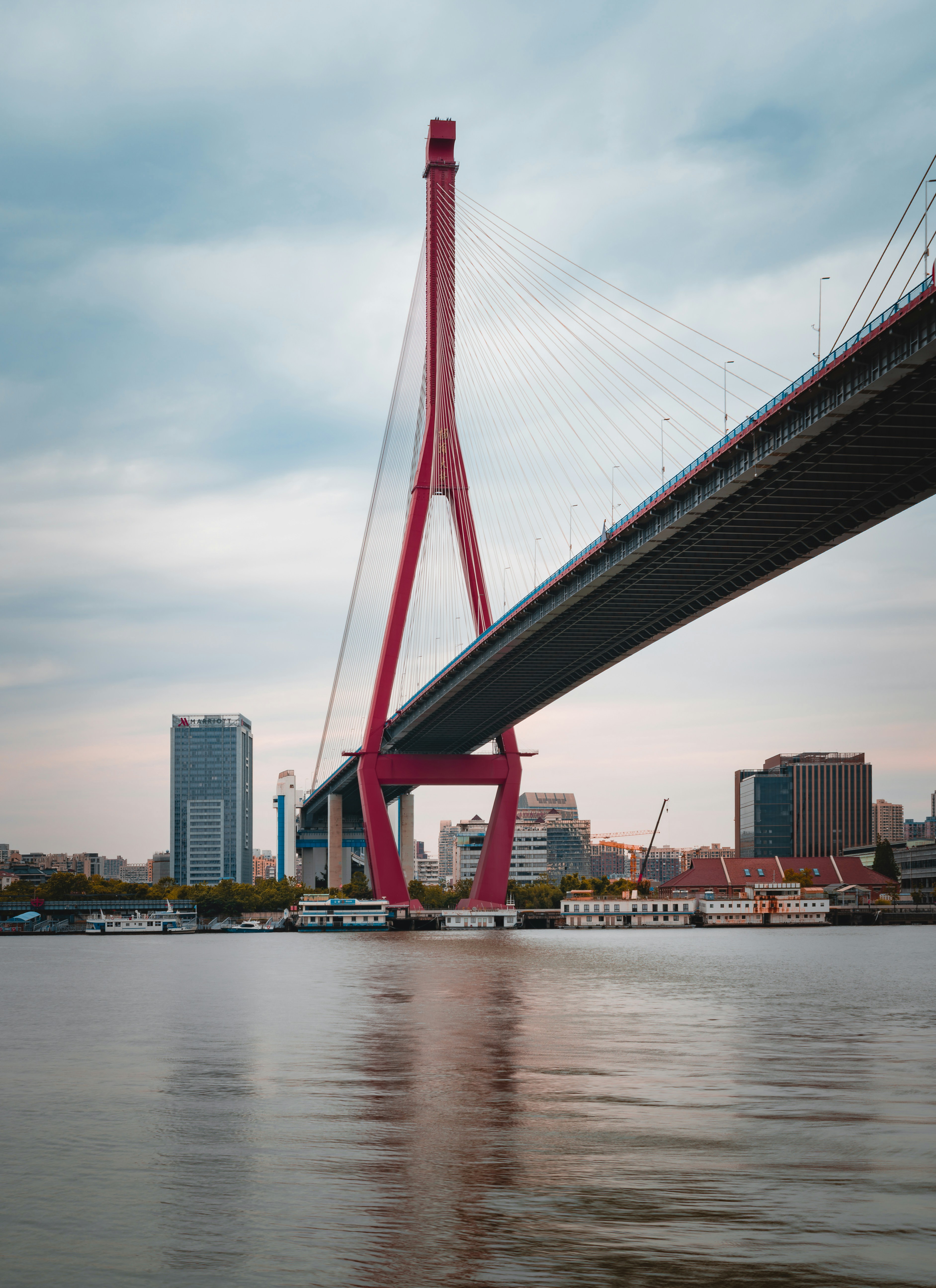 A Red Cable-Stayed Icon Over the River