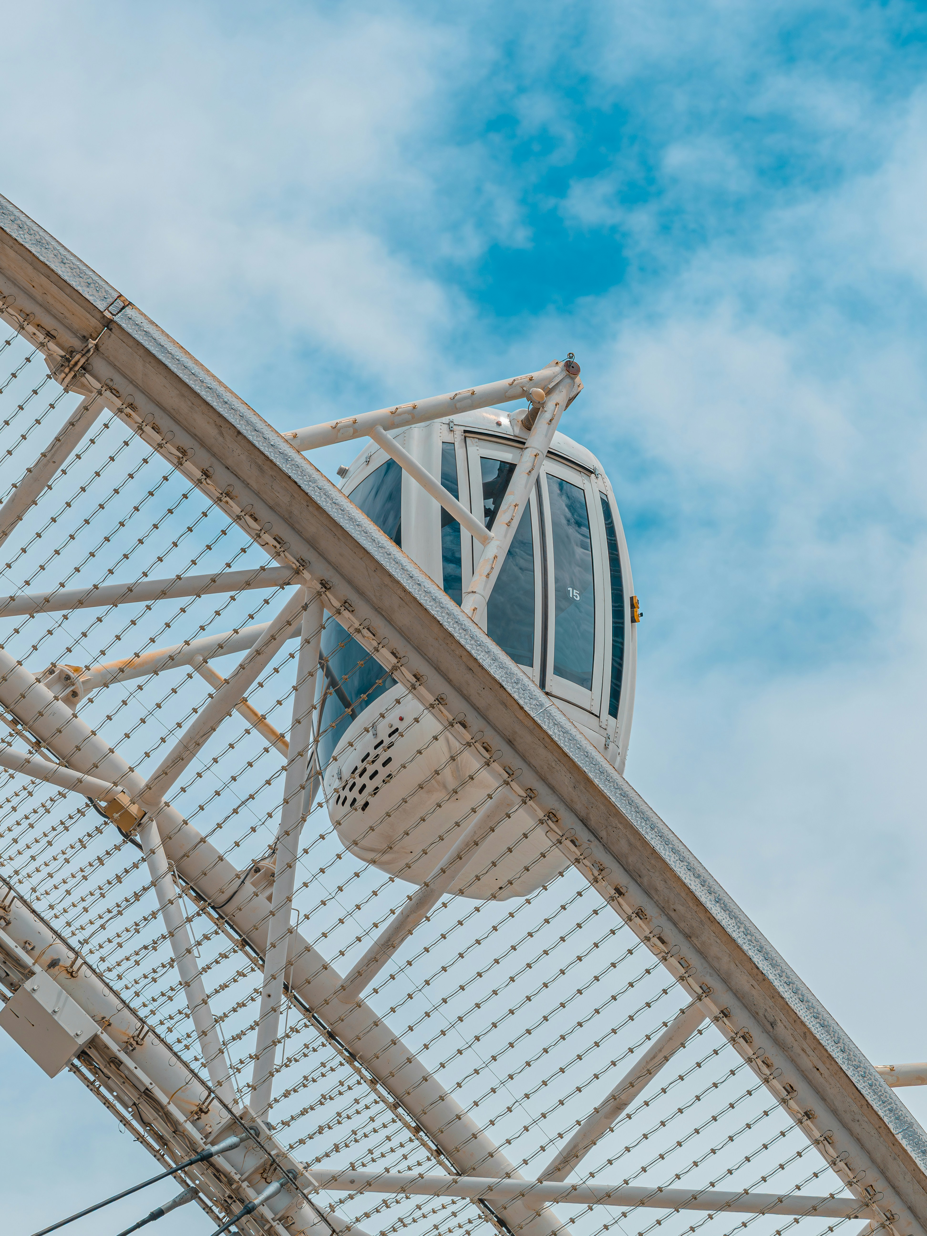 Above the Skyway: A Cablecar Pierces the Blue Canopy