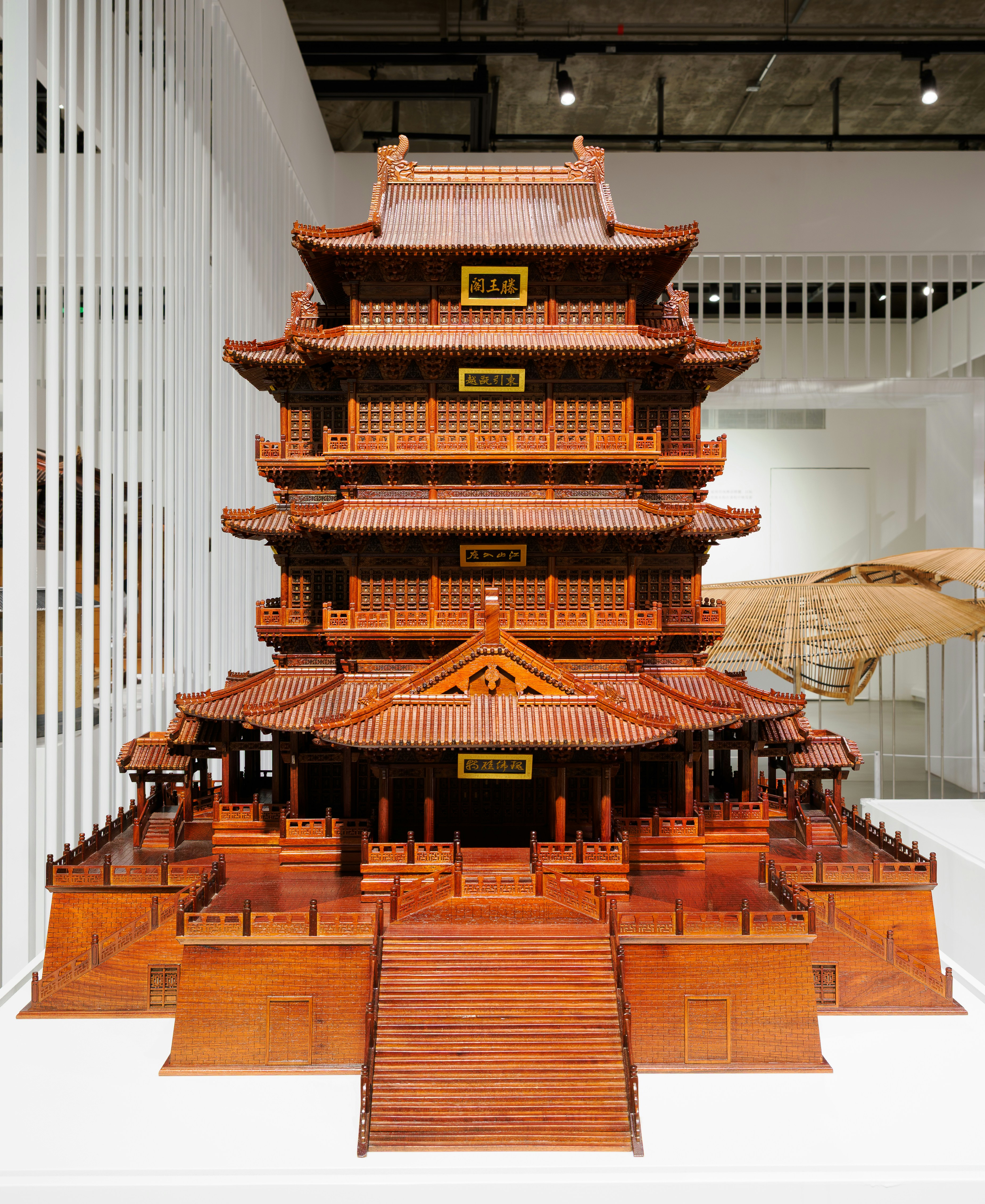 Intricate miniature pagoda carved in warm wood on display