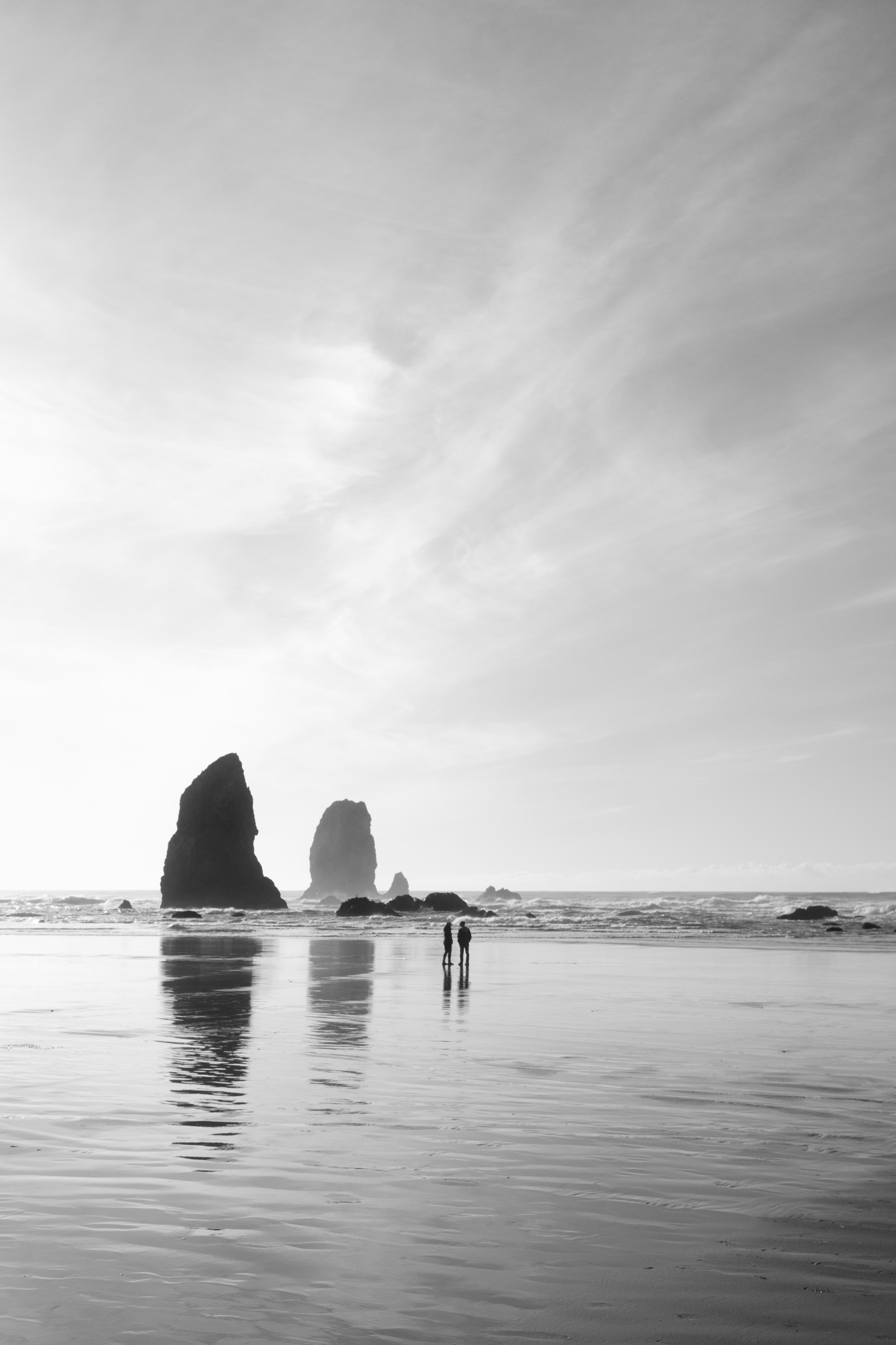 Silent Rocks at Dusk: Two Figures at the Shore