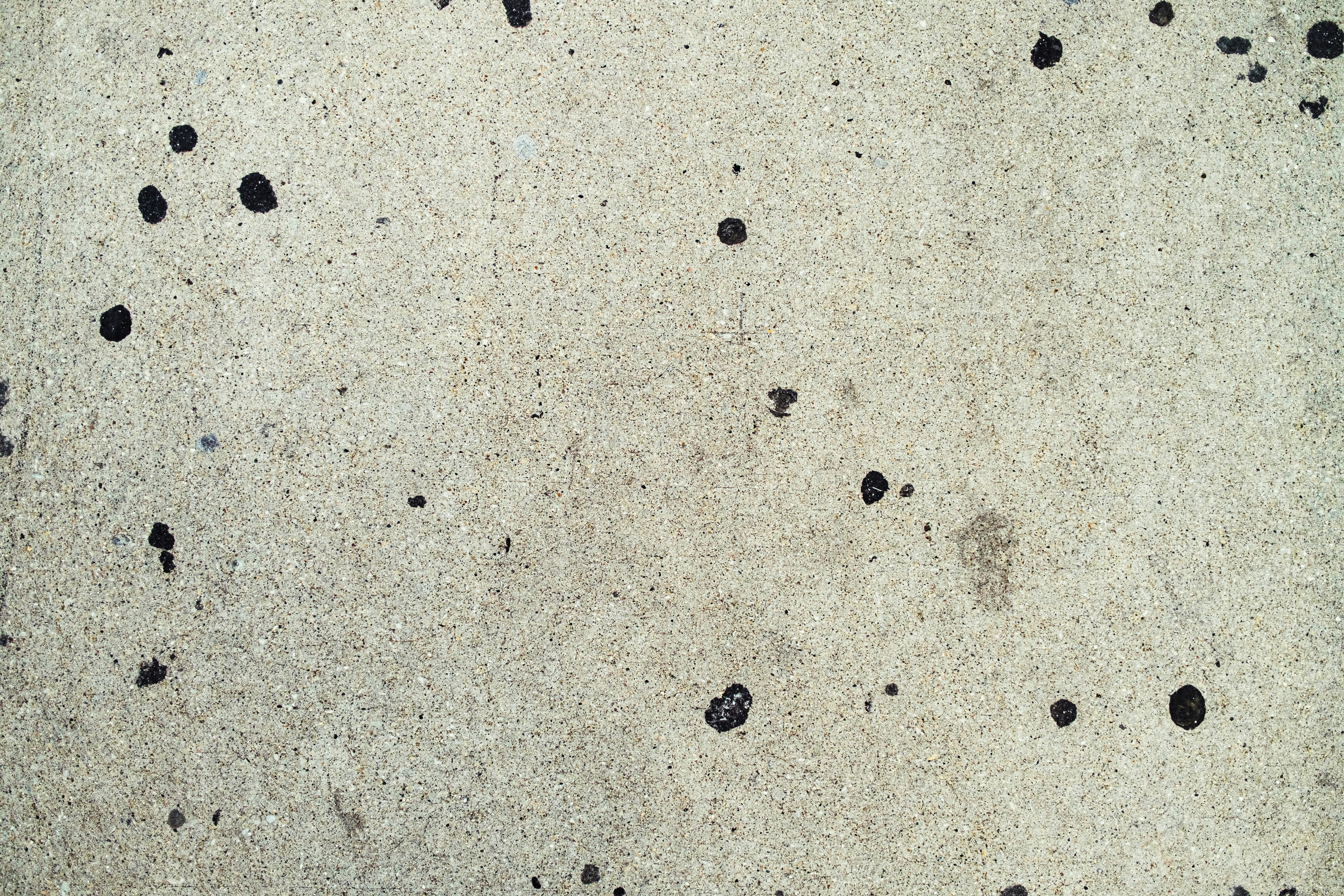 Spotted Concrete: Quiet Texture of a Street–level Wall