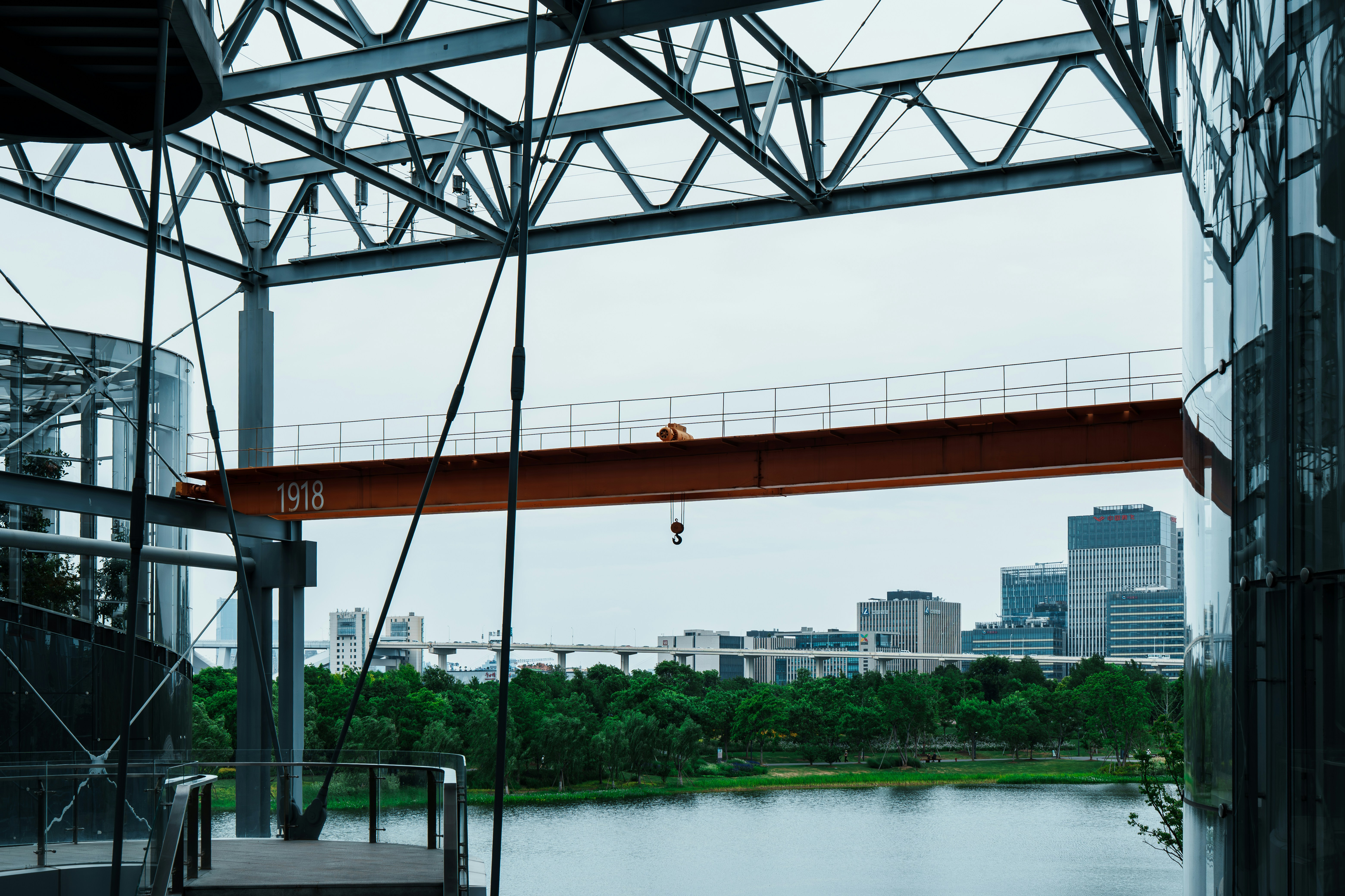 Industrial Crane Span Over a Riverside Cityscape
