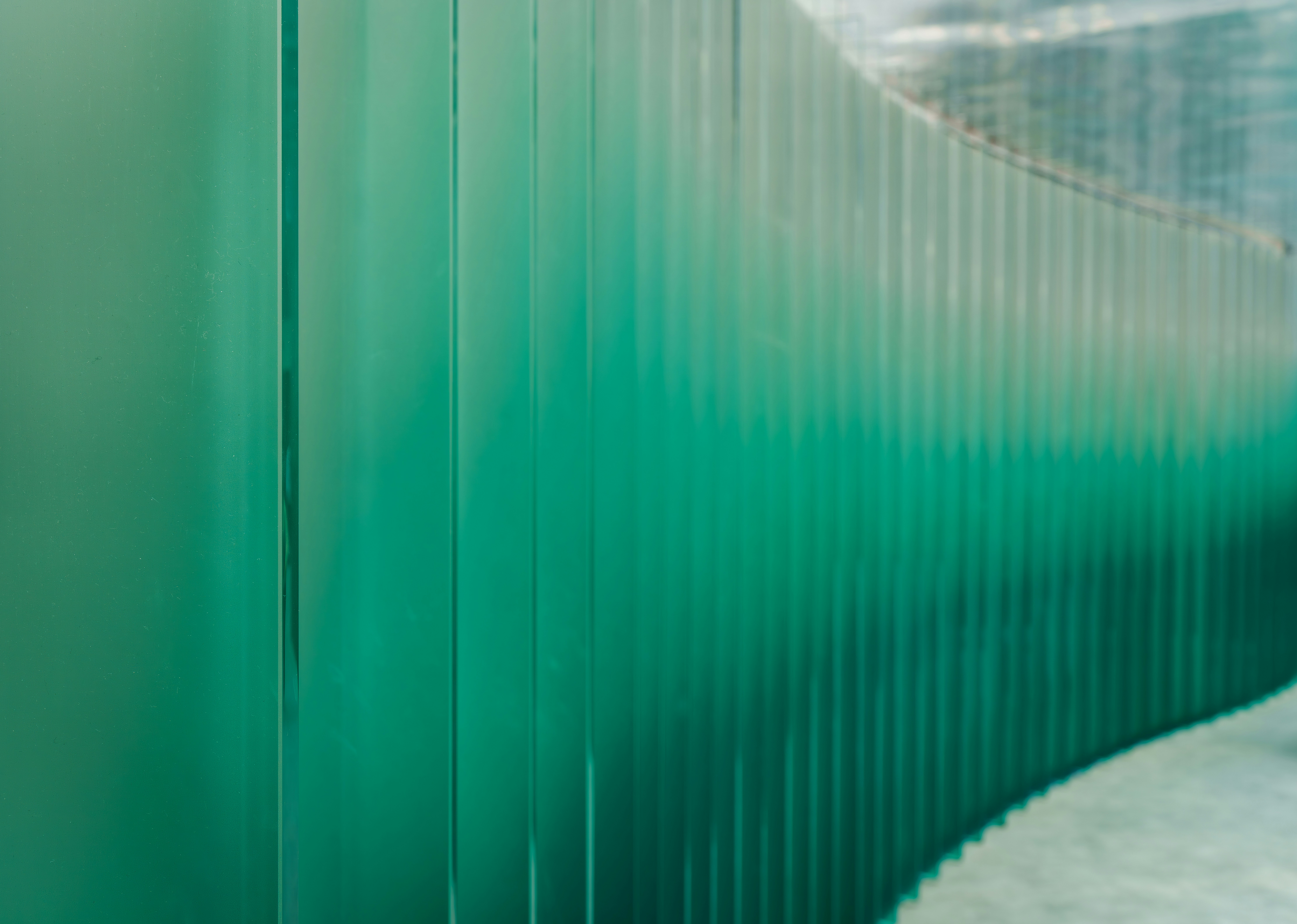 Emerald Curve: A Tiled Wall Recedes into Light
