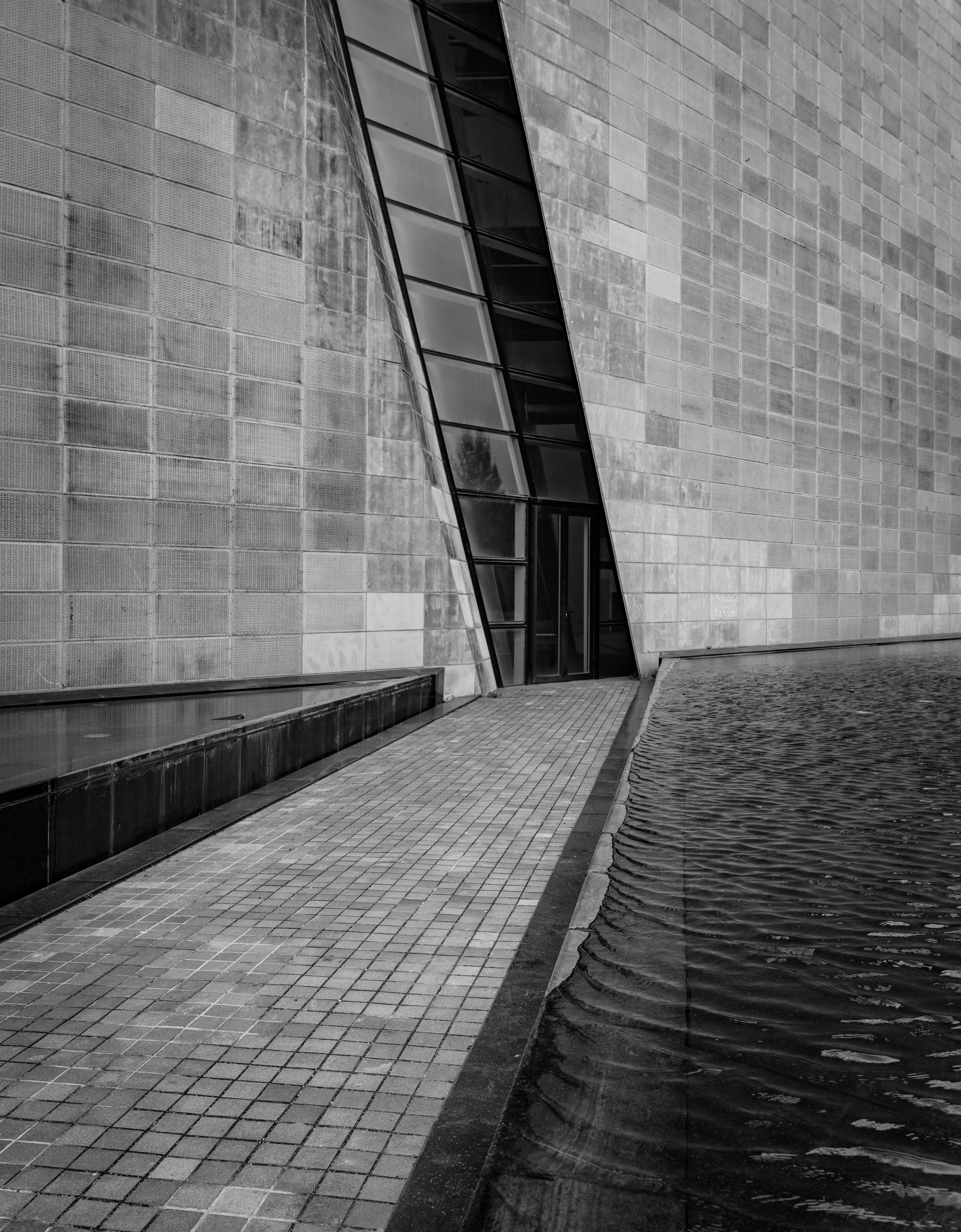 Diagonal Facade and Reflective Water: A Study in Concrete Angles