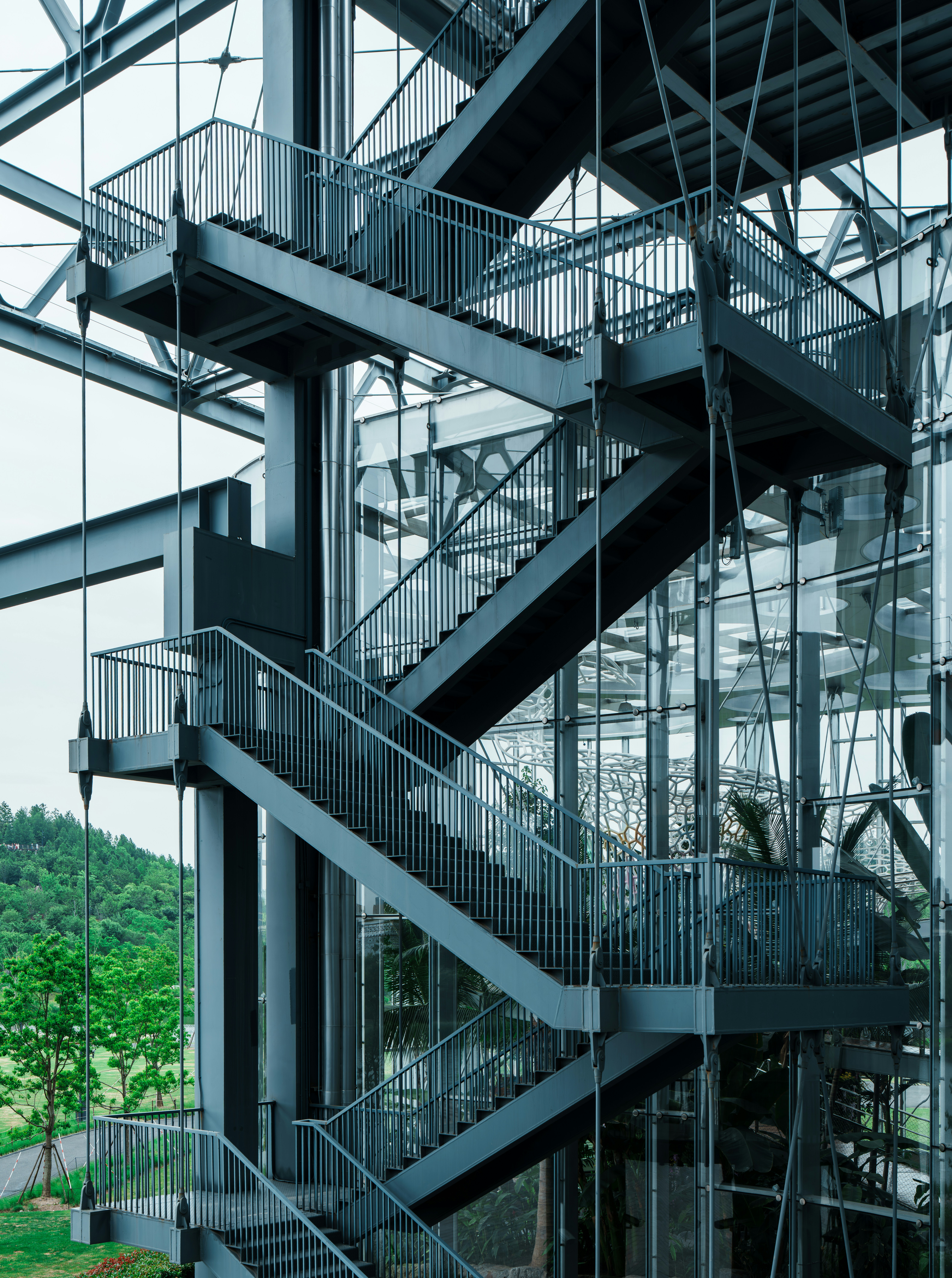 Industrial Staircase Web: Geometric Metal Staircases Against Glass Facade