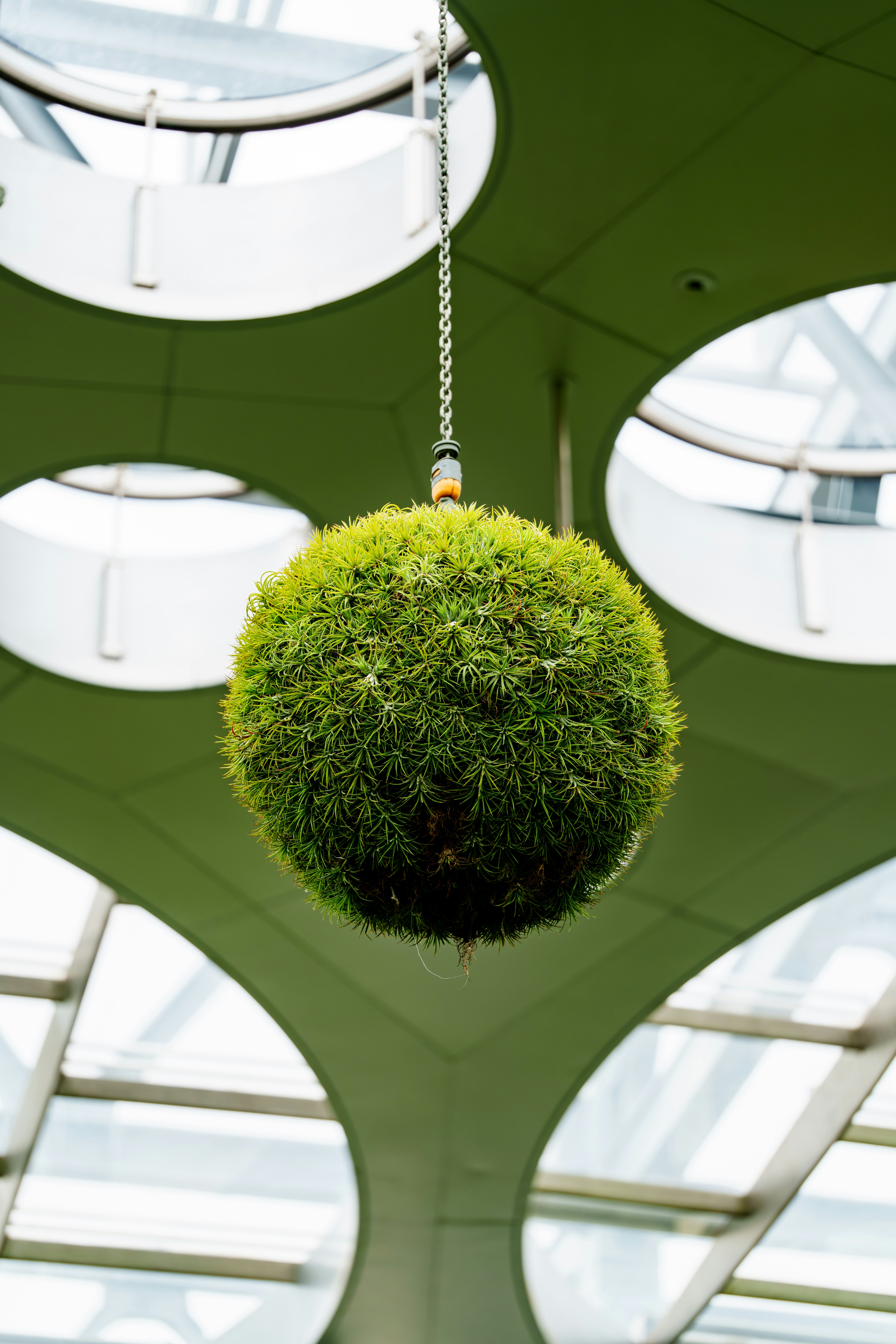 Hanging Green Sphere in a Modern Atrium
