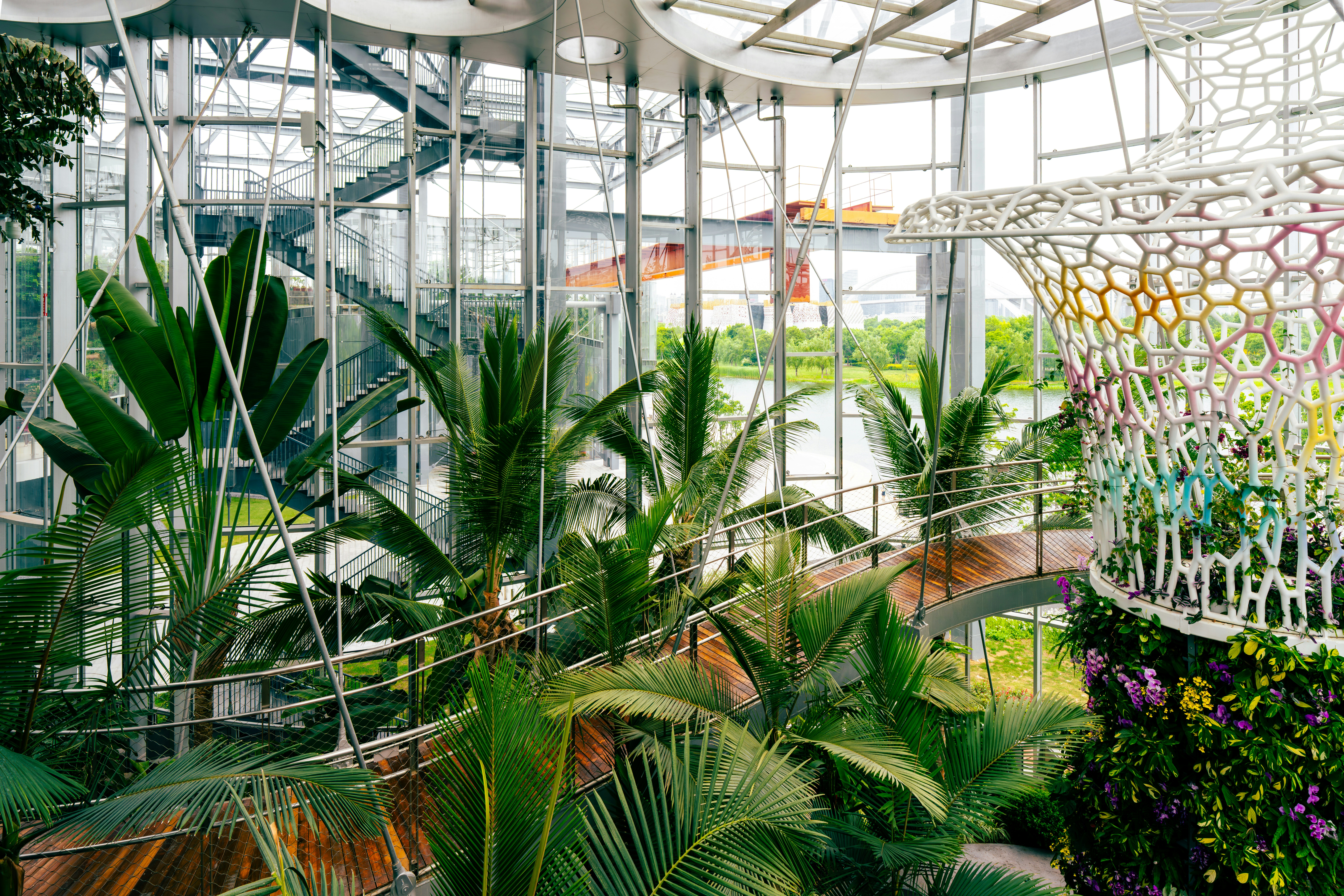 Verdant Atrium Curve: A Glass-Encased Jungle With Lattice Canopy