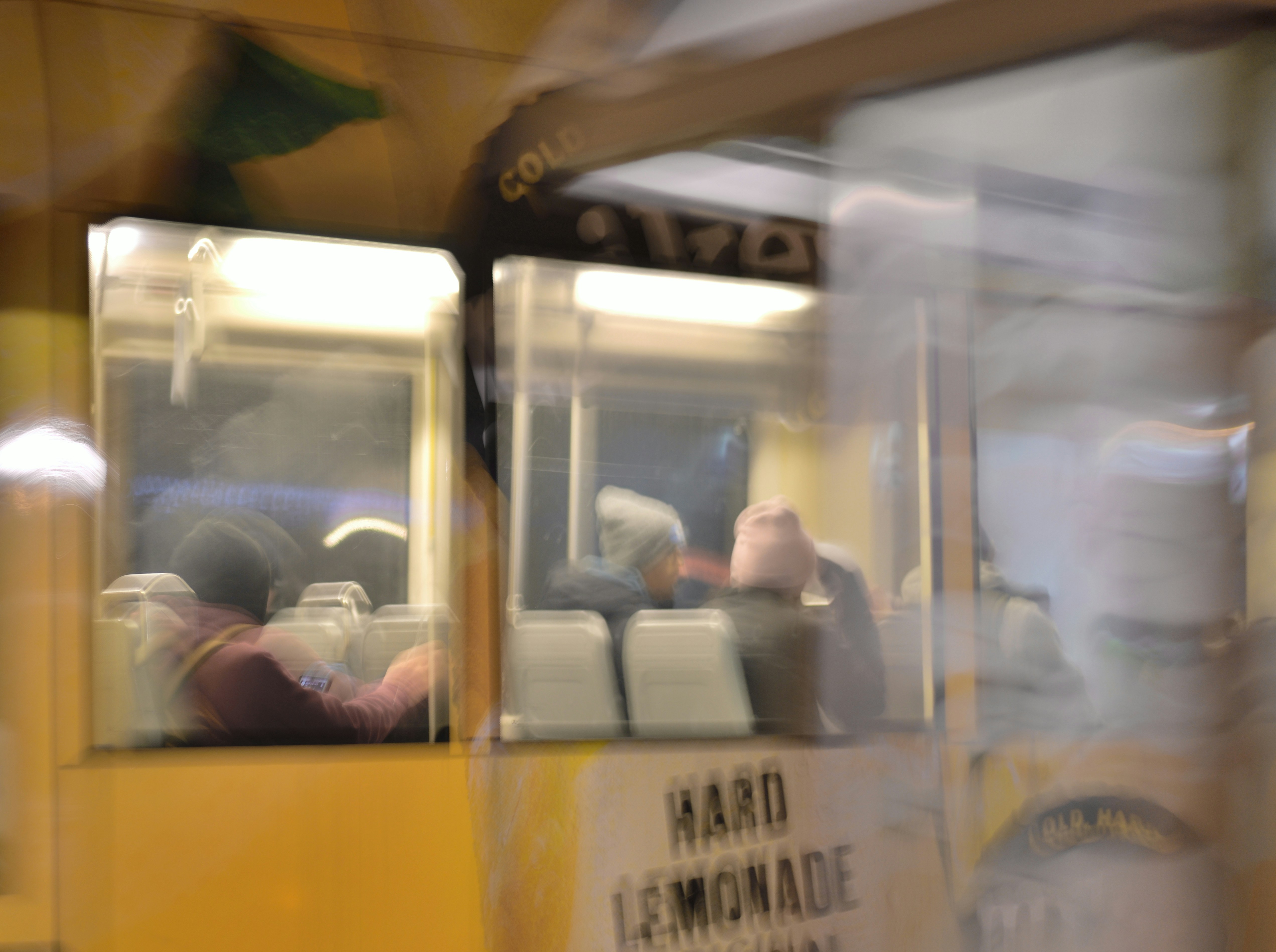 Motion Blur of a Yellow Bus Cabin with Passengers