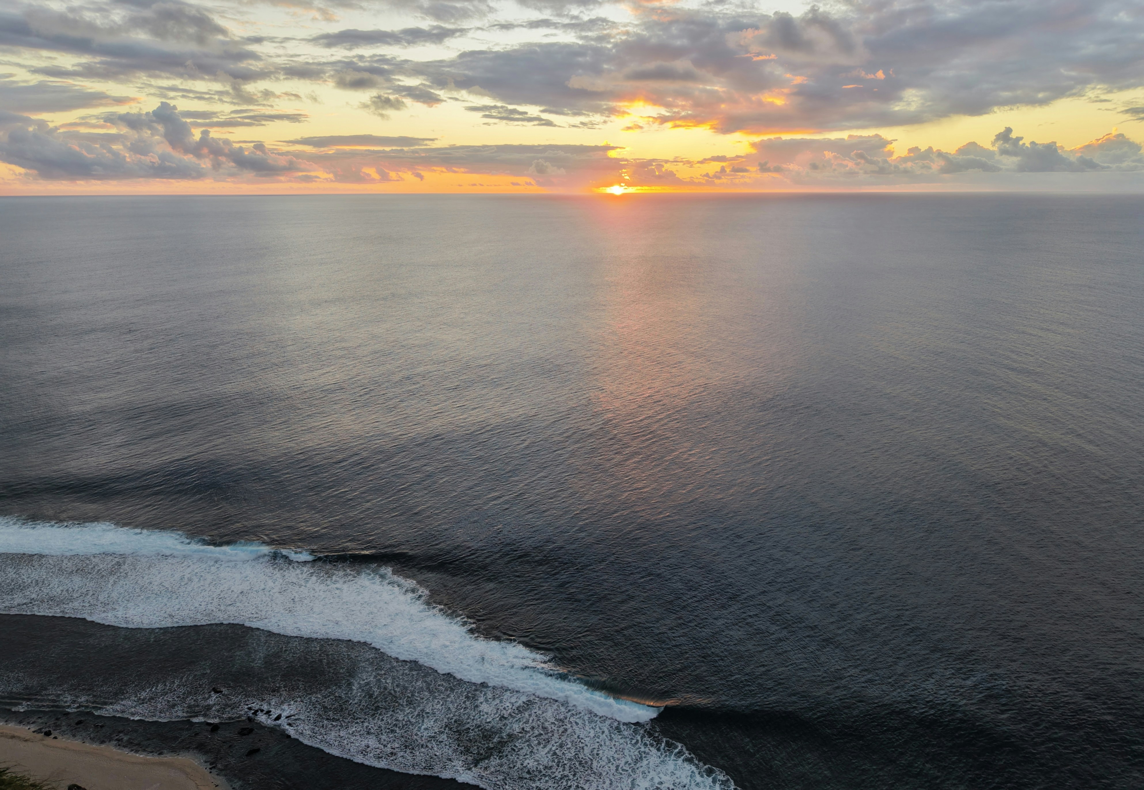 Sunrise Break over a Quiet Ocean