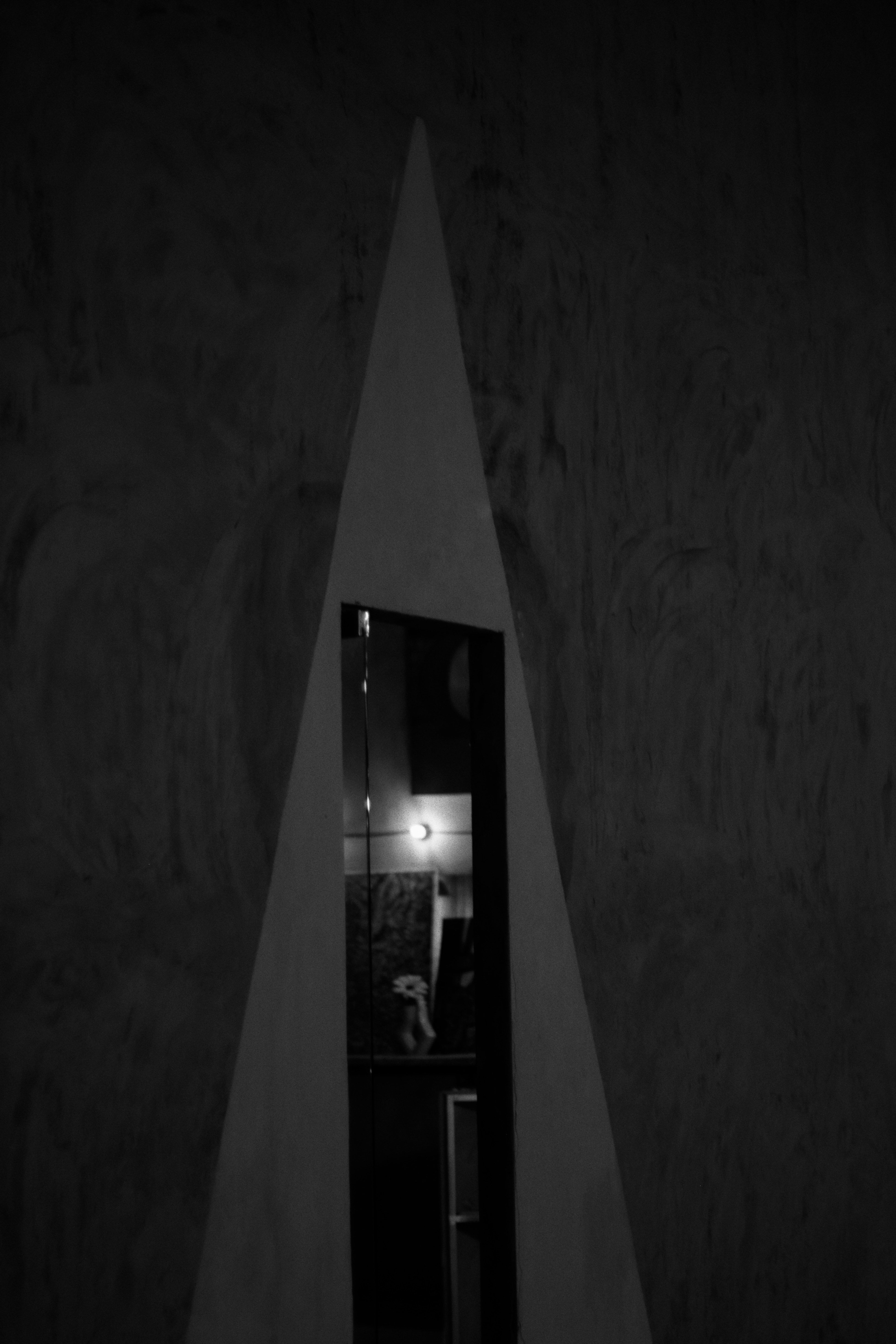 A Narrow Sliver of Light: Doorway in a Dark Wall