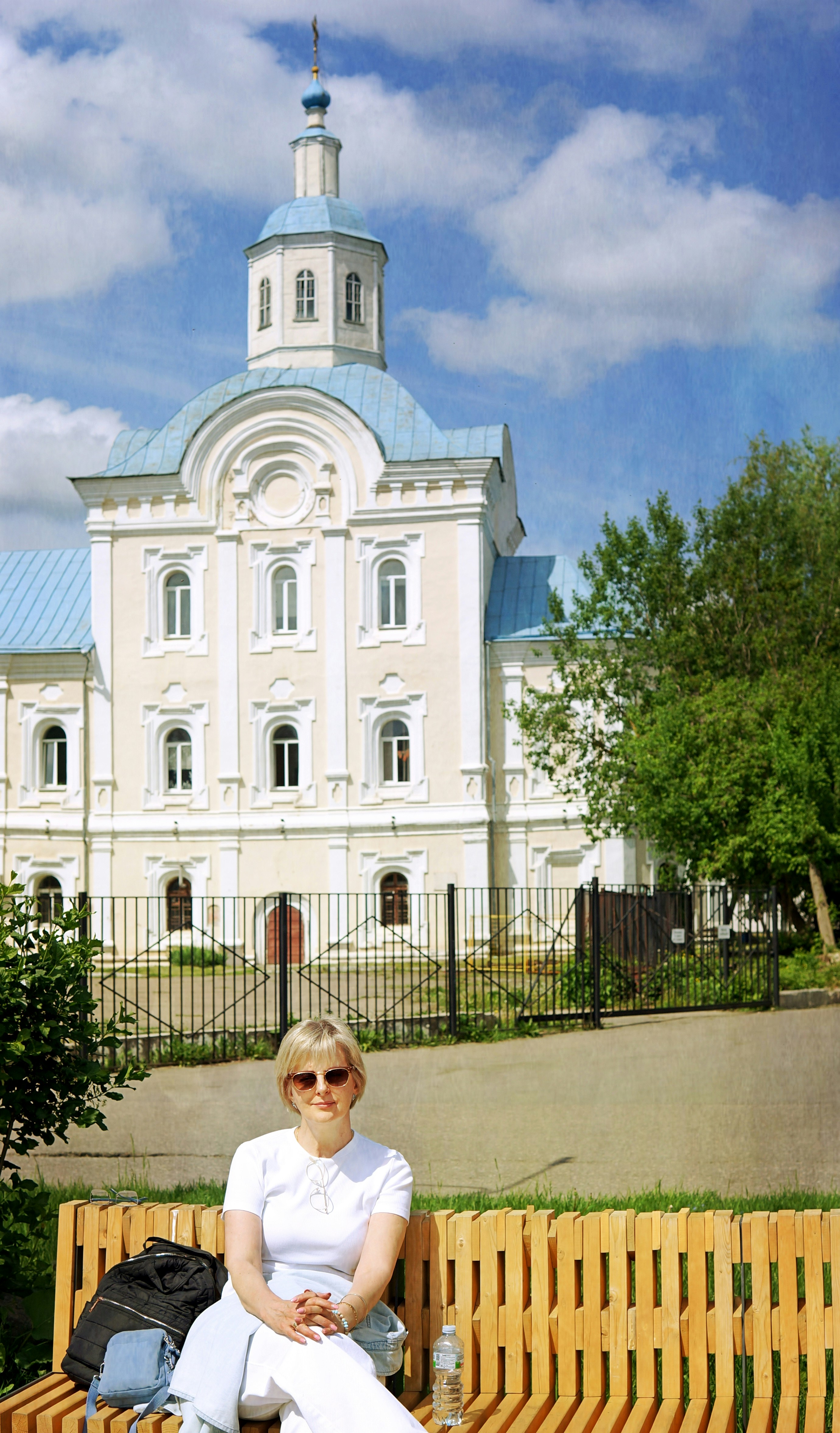 Sunlit Facade and Quiet Sit — A Petaled City Scene
