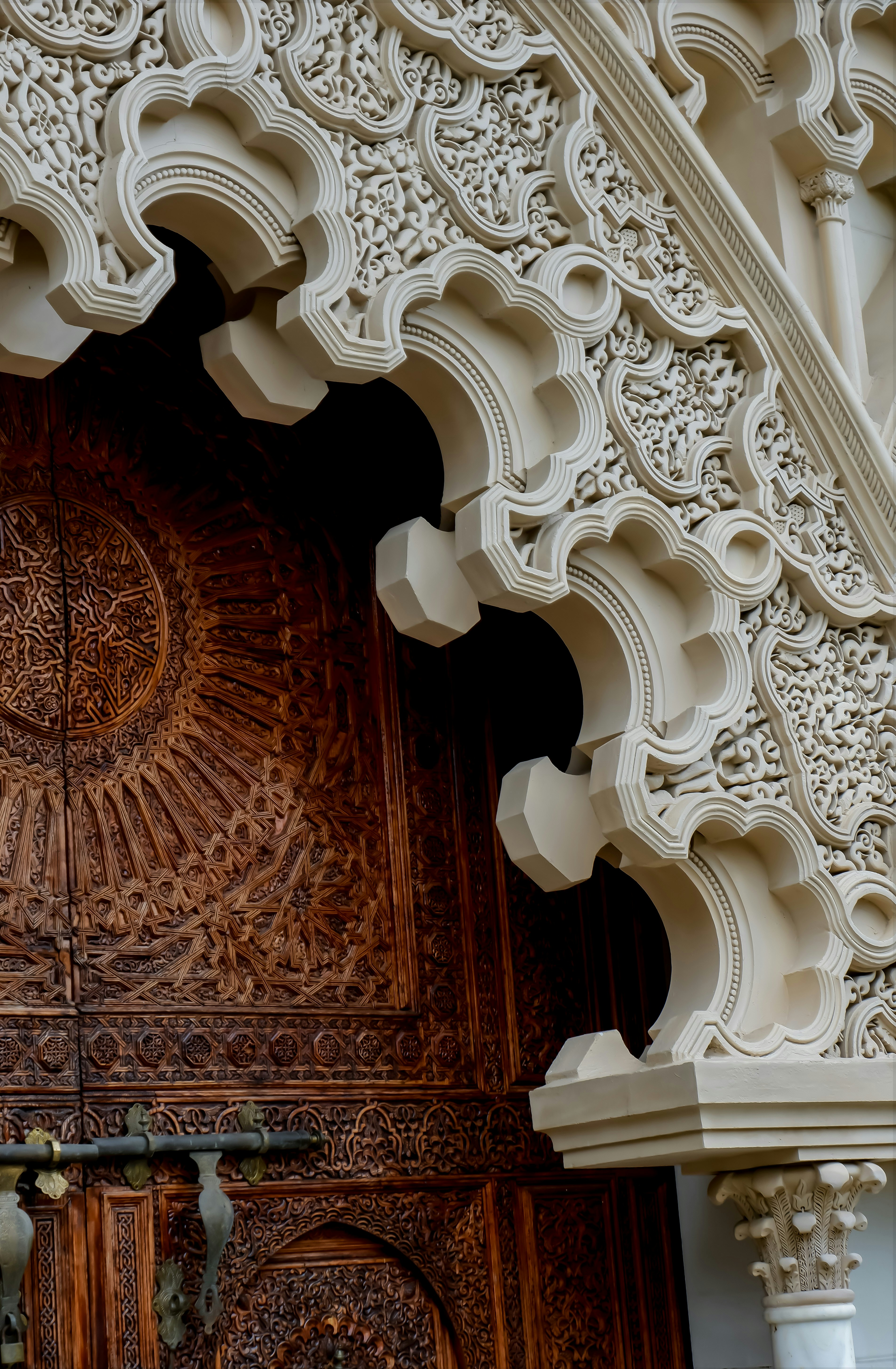 Ornate Archway Over Dark Carved Door