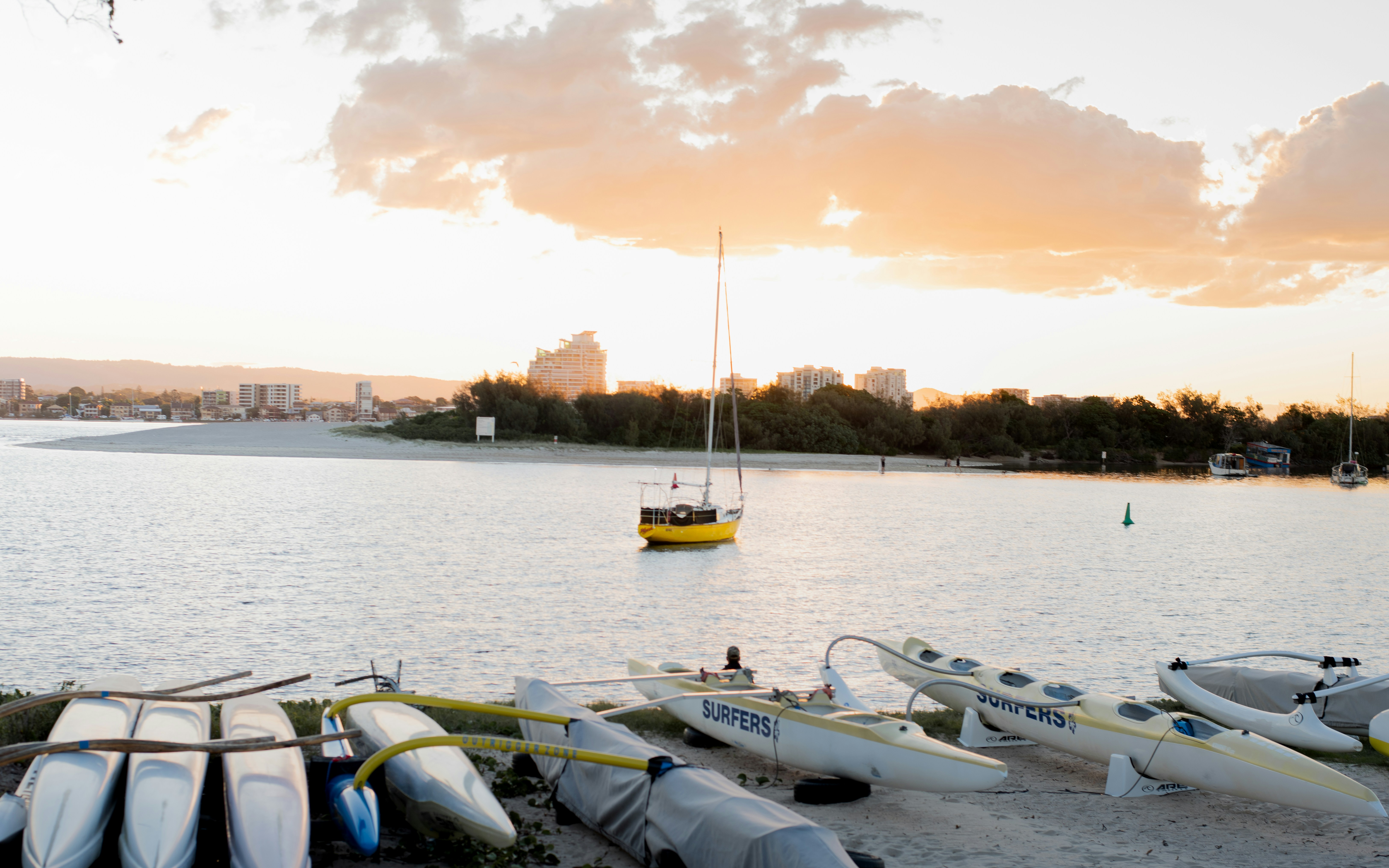 Yellow-sailed Boat at a Calm Marina at Sunset