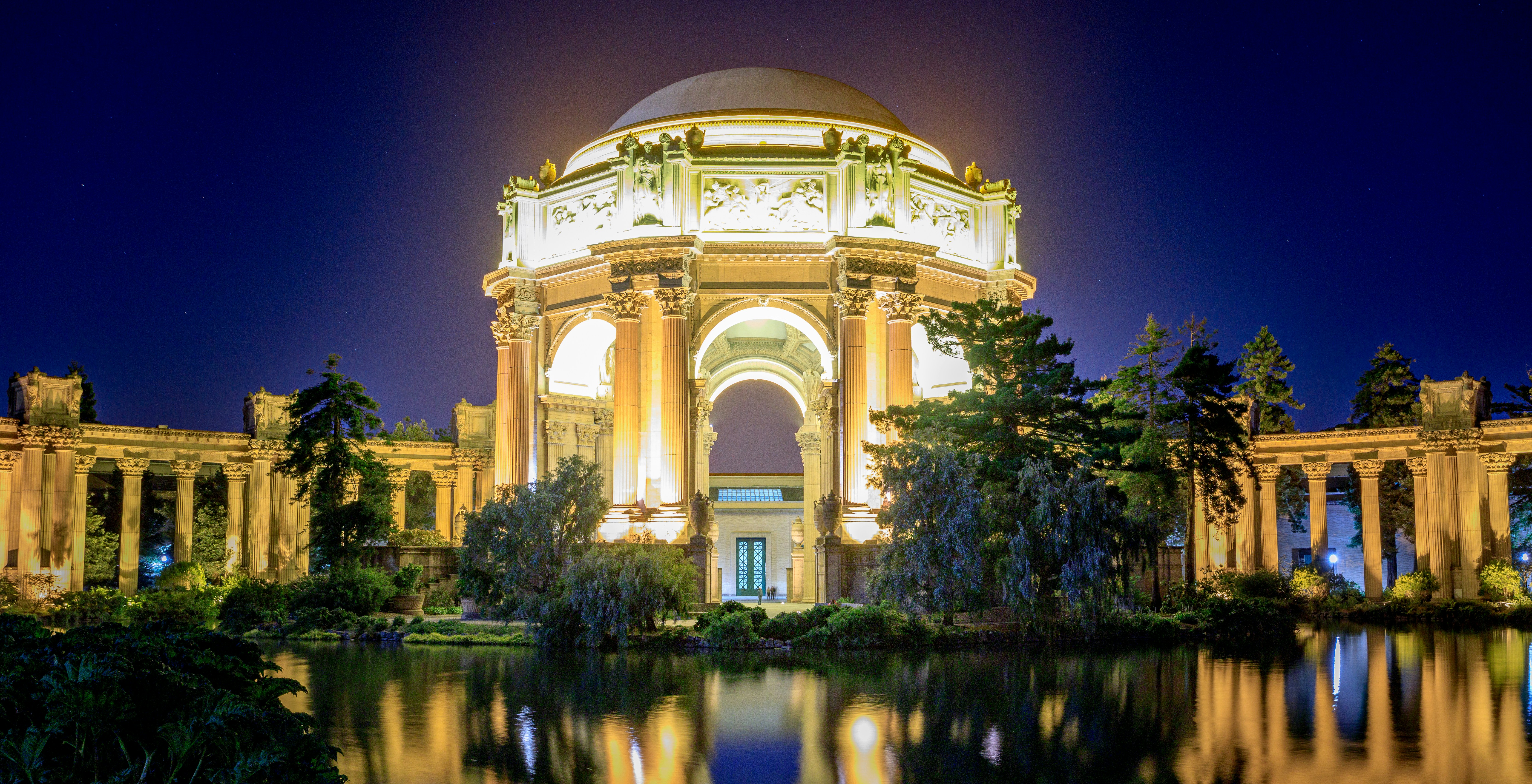 Illuminated Rotunda at Night: Echoes of Light over a Moonlit Plaza